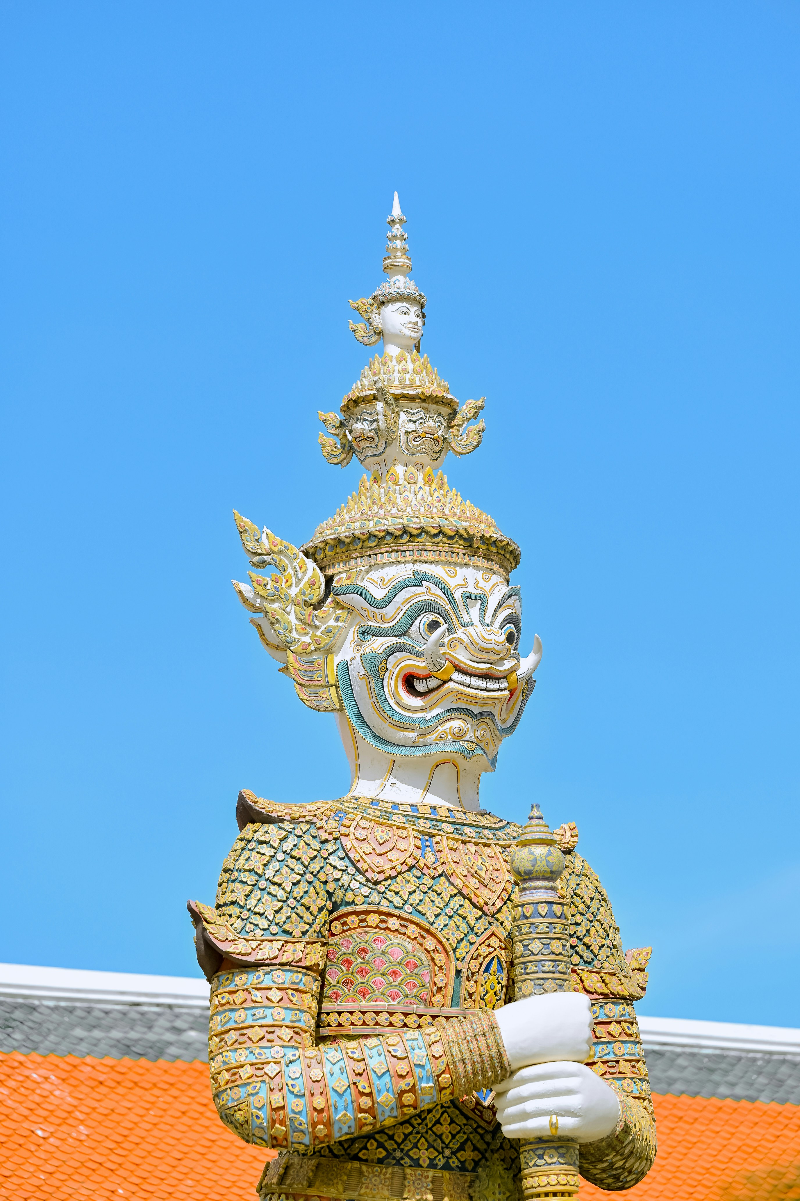 Golden Guardian: Dragon-Headed Warrior Against a Clear Sky