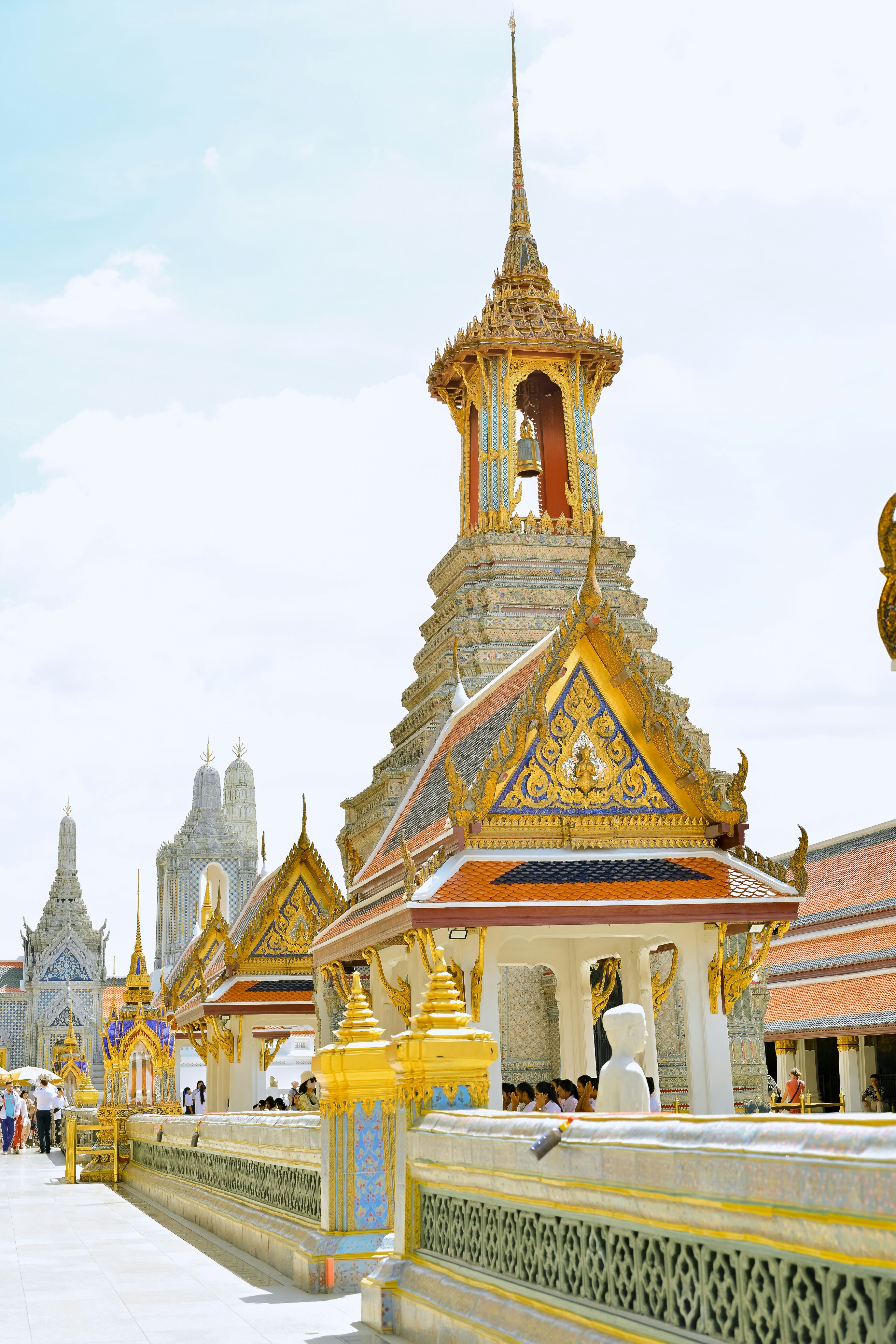 Golden Temple Towers Above a Courtyard of Ornate Thai-Thai Inspired Rooflines