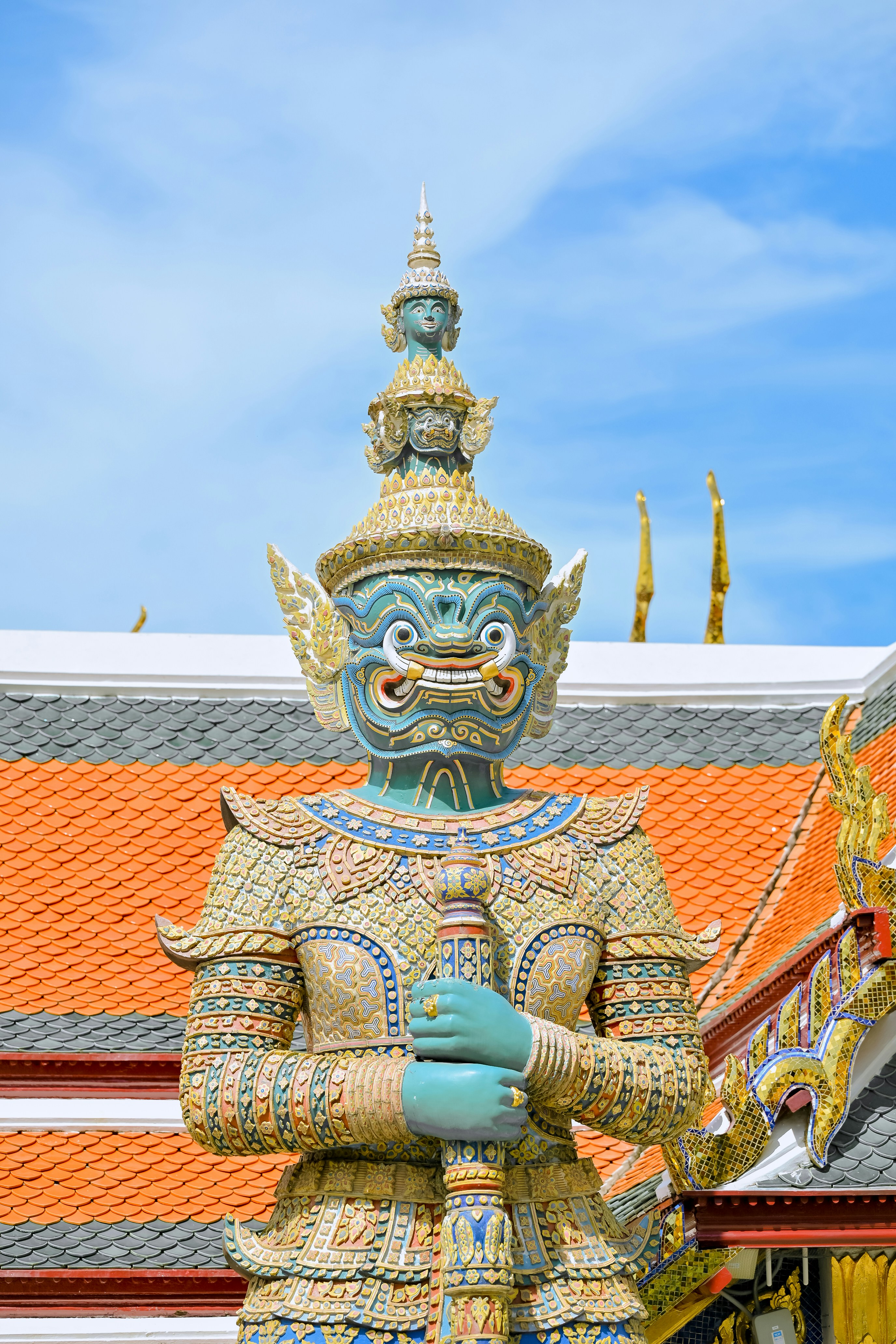 Ceremonial Guardian: A Turquoise-Toned Warrior Stands Beside the Temple Roof