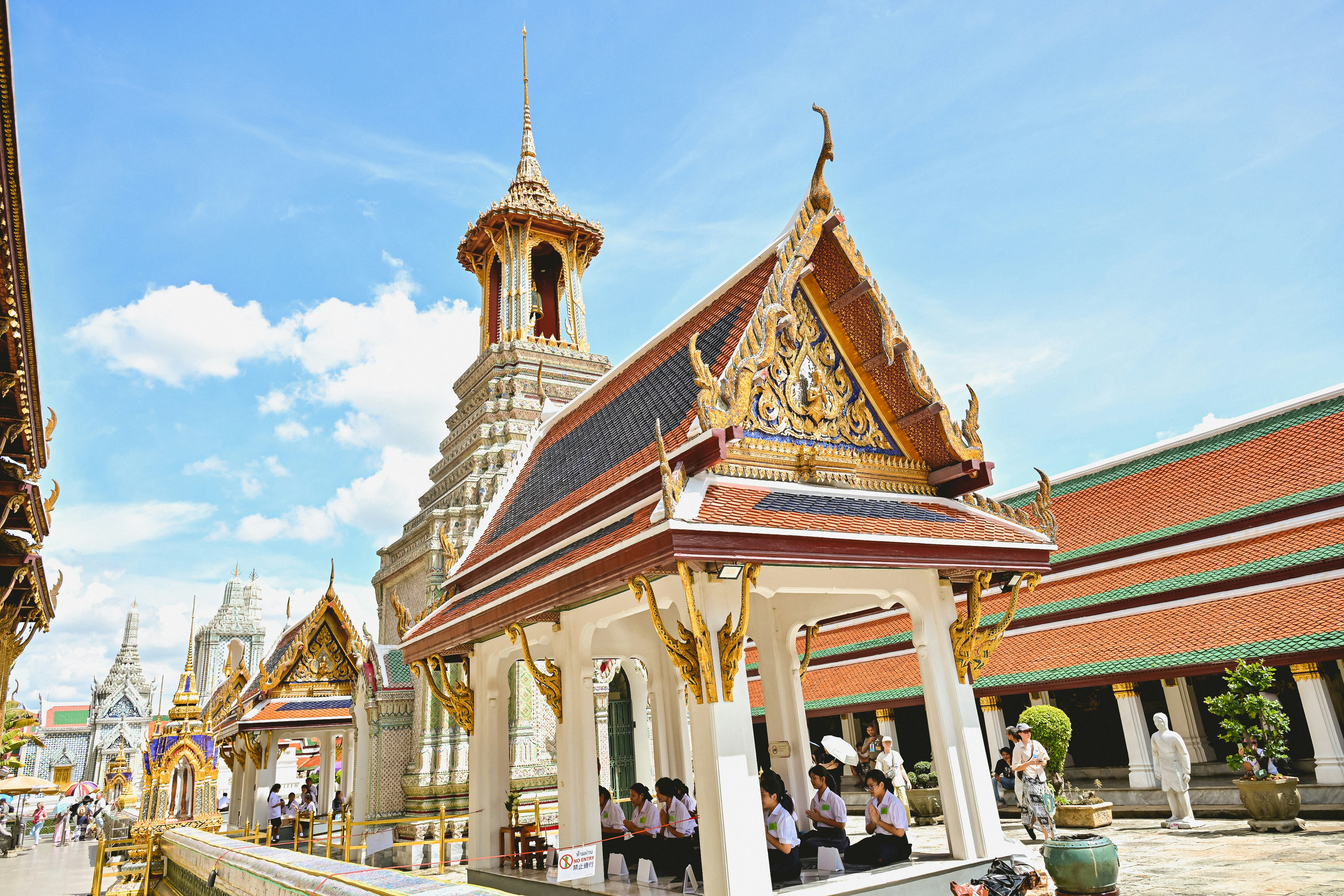 Temple Courtyard in Bright Thai Light with Ornate Rooflines