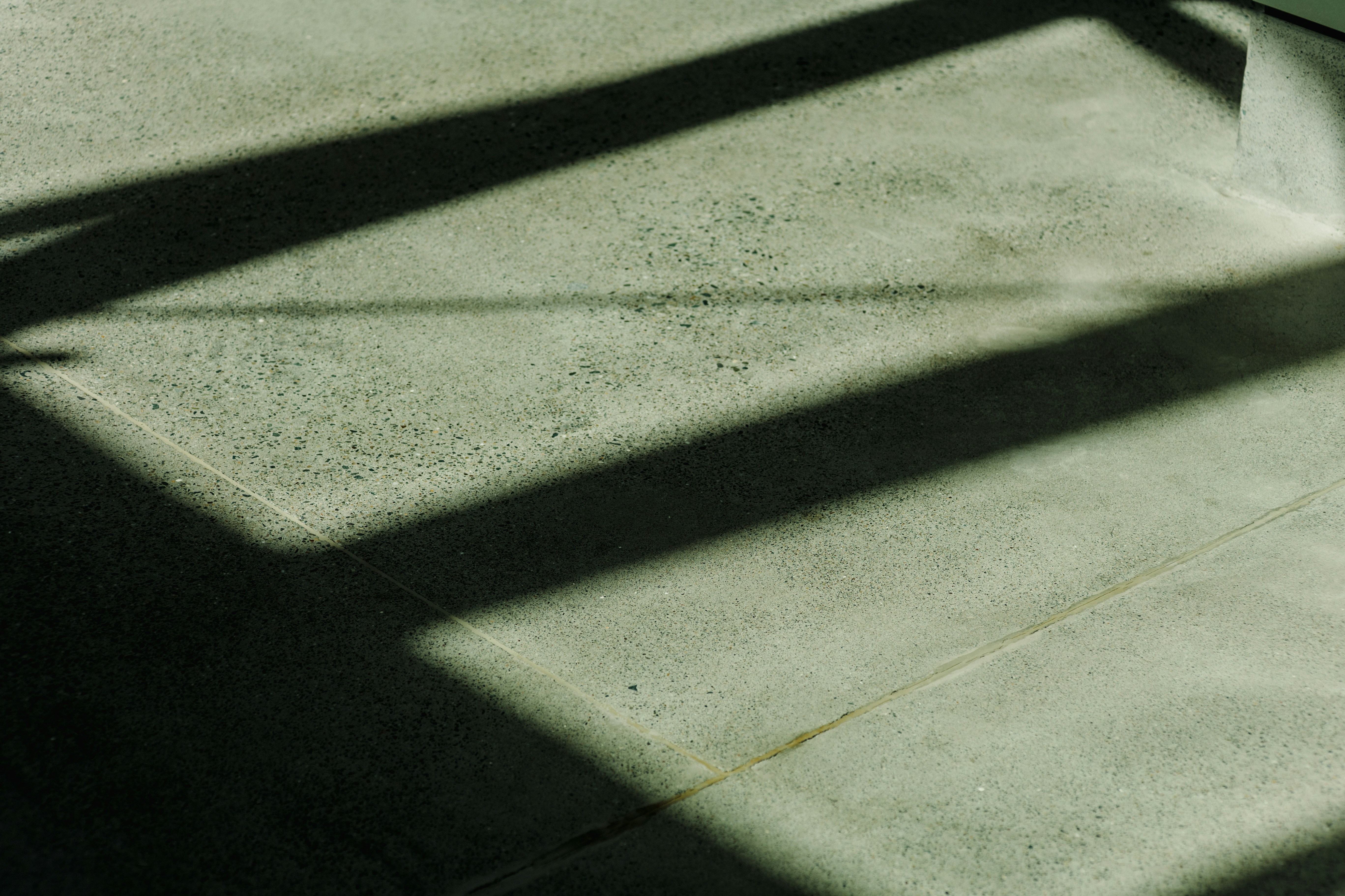 Shadowed Floor — Geometric Play of Light on Concrete