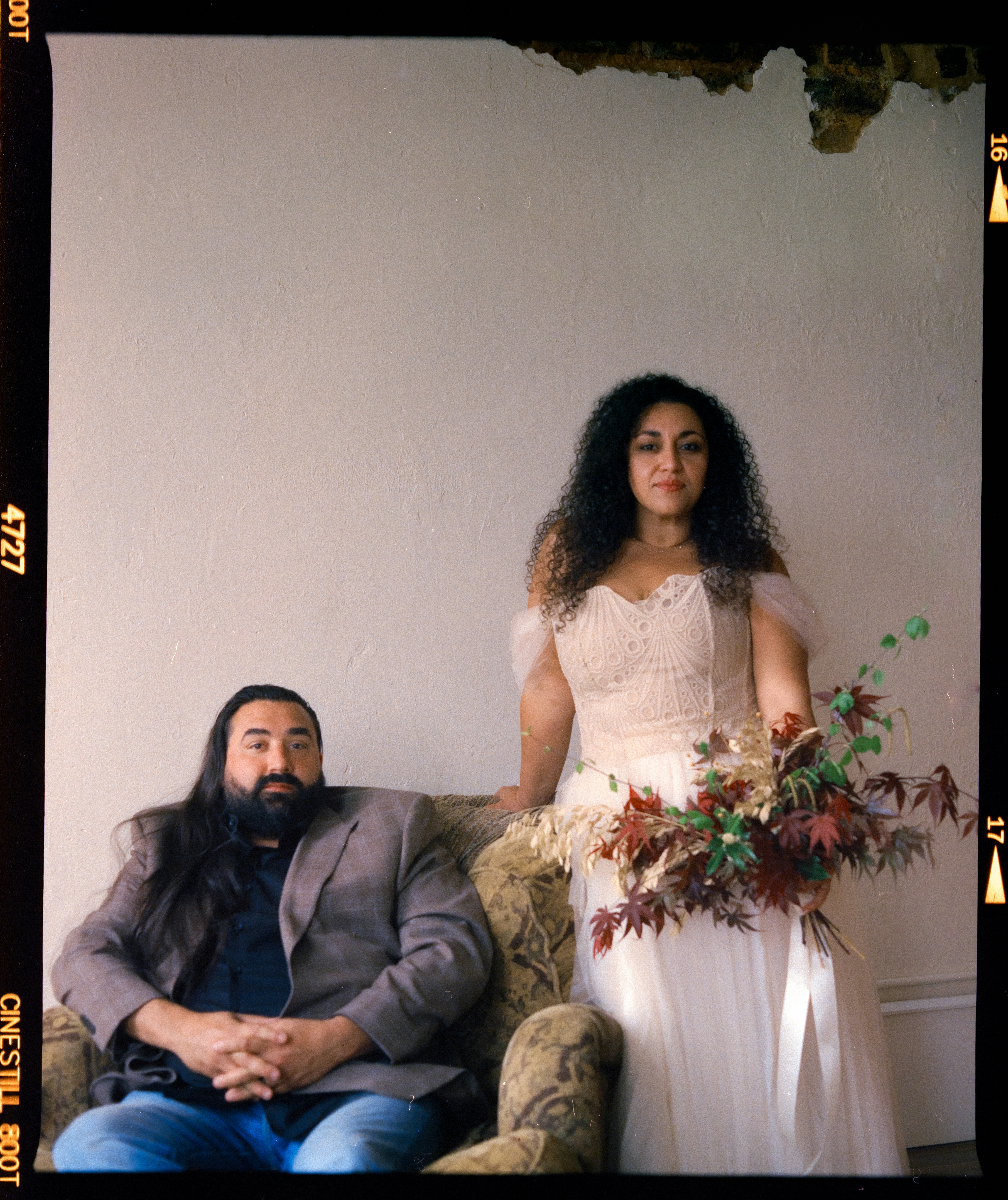 Elegant Union: Bride and Groom in a Quiet Living Room Moment