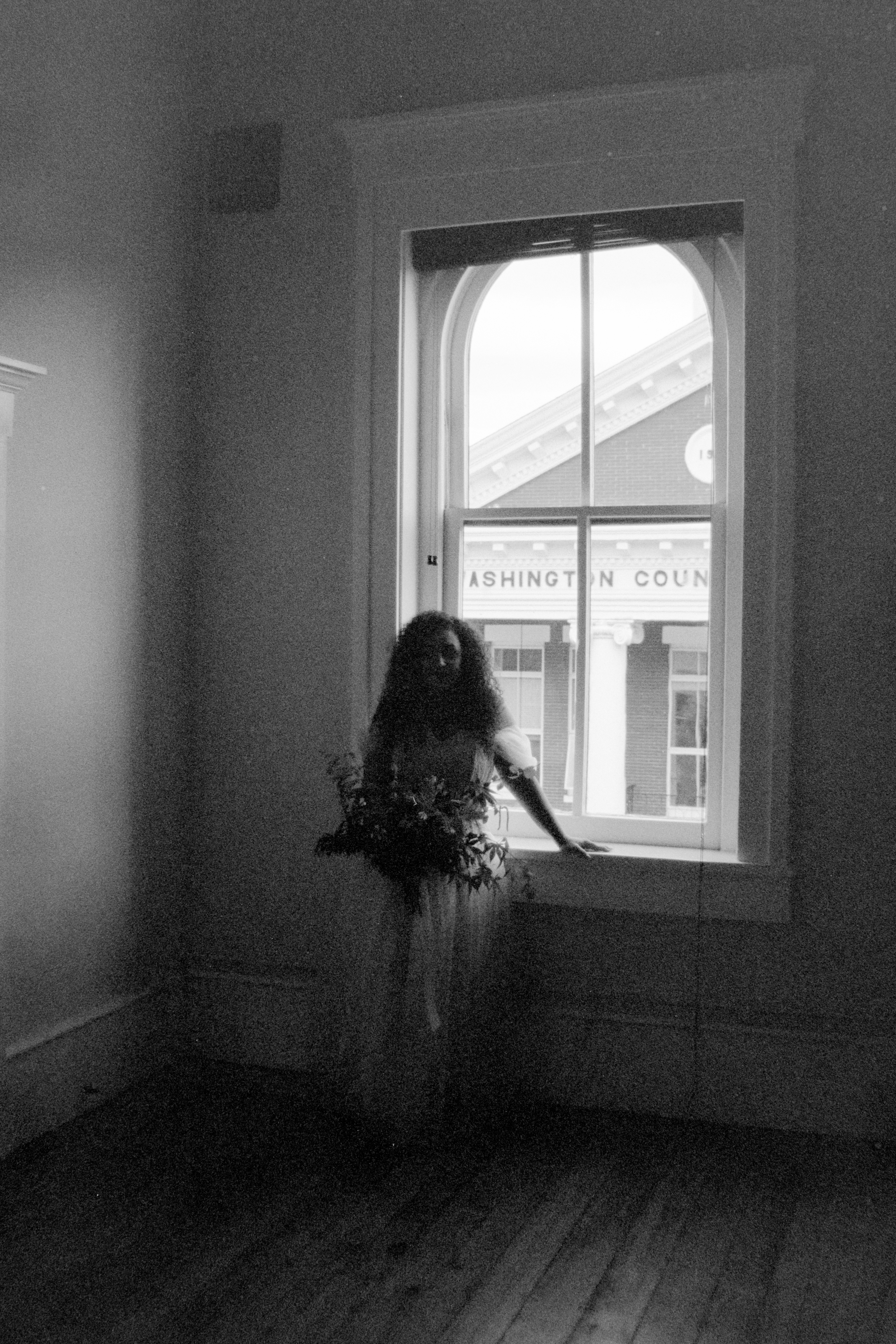 Ghostly bouquet by the window in a dim room