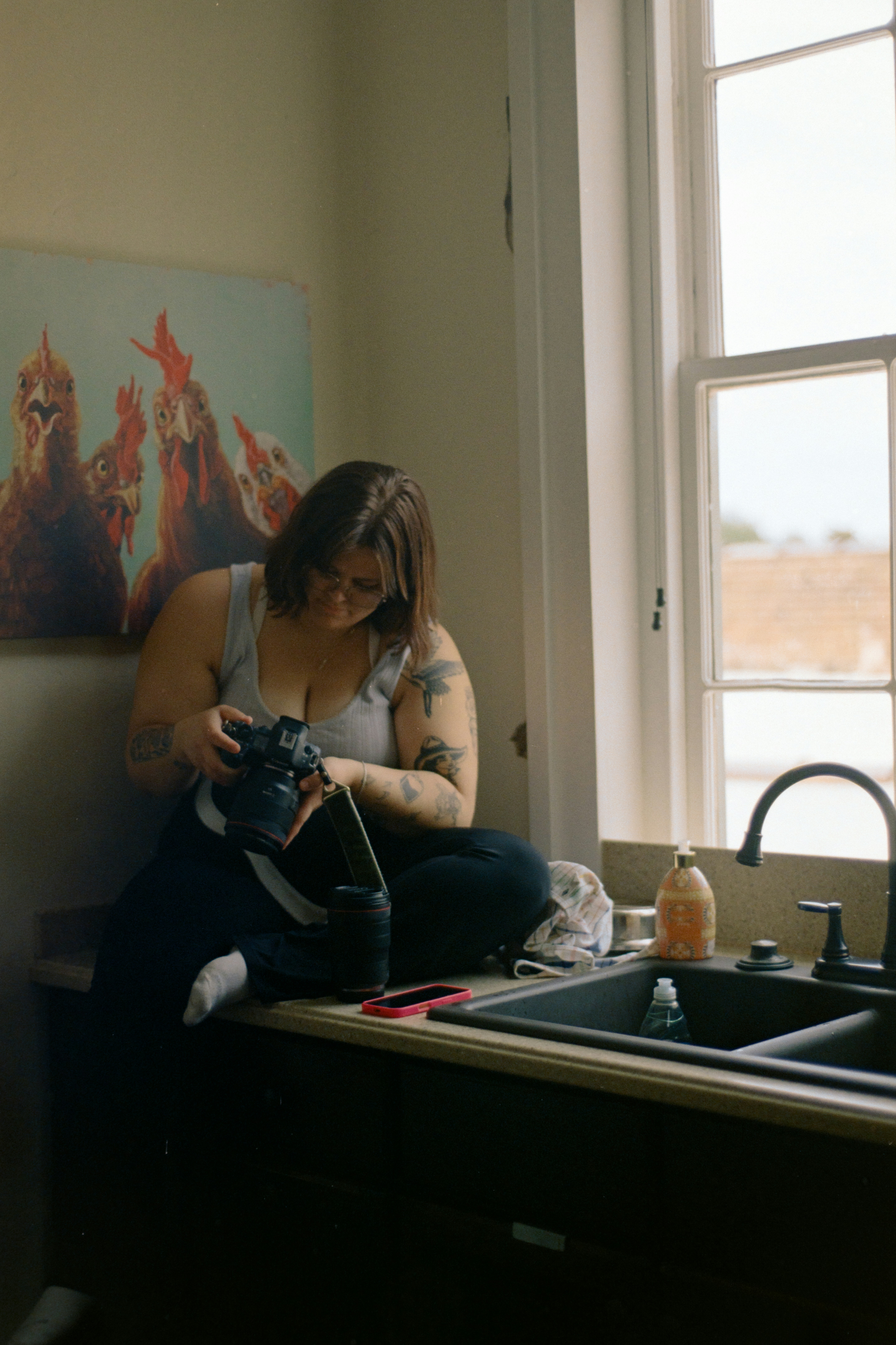 Quiet Focus: A Photographer in Warm Kitchen Light