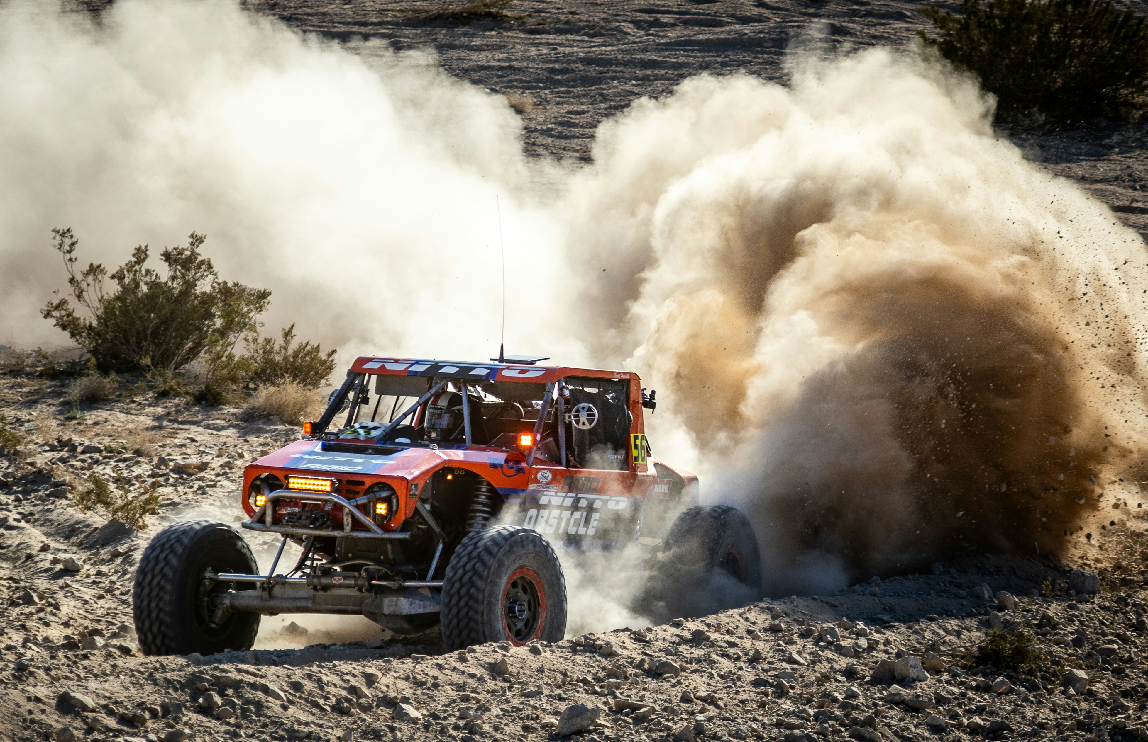 Dusty Burst: Off-Road Power Surging Through Desert Gravel