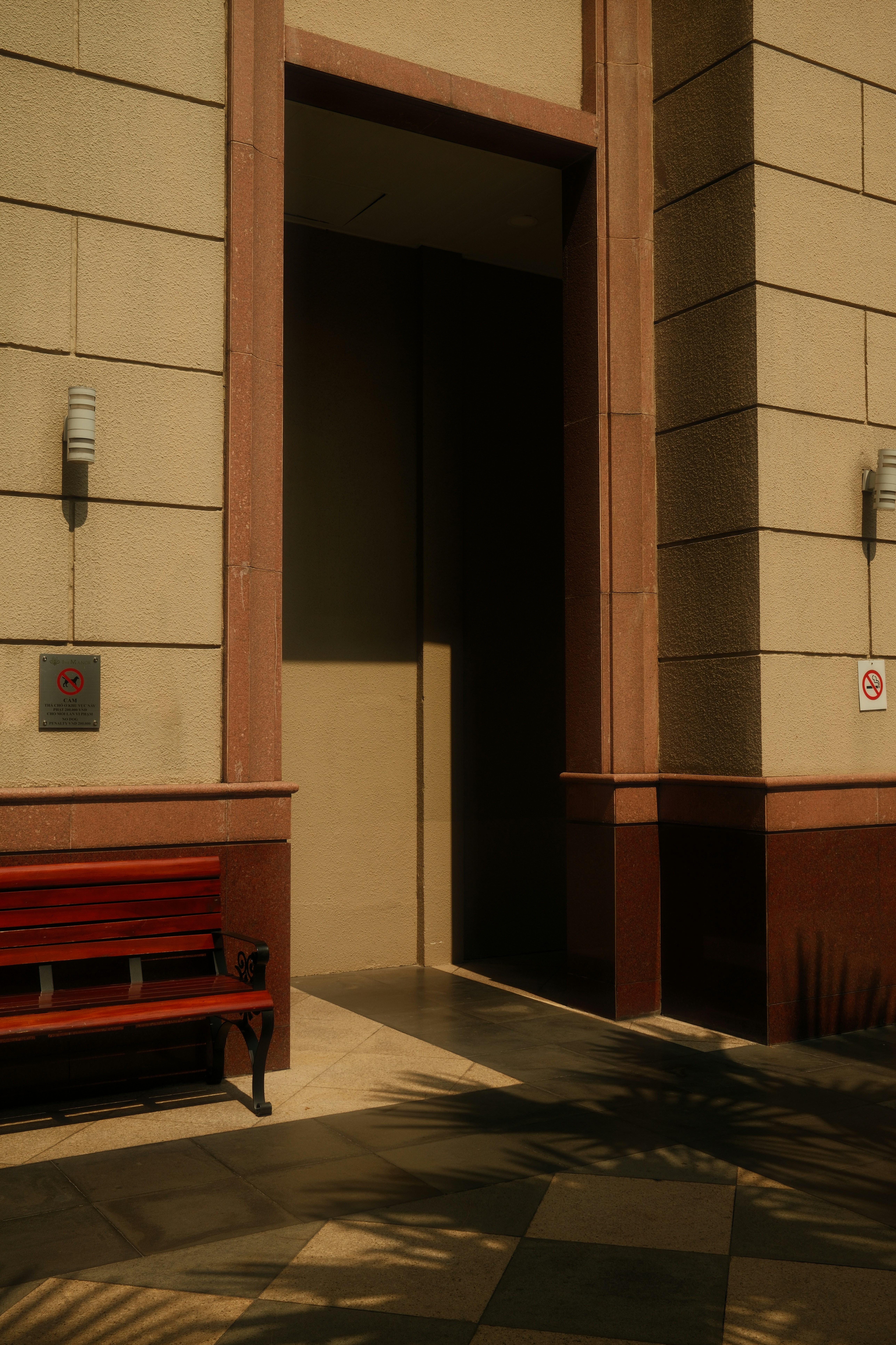 Shadowed Portal: Sunlit Entrance to a Quiet Courtyard