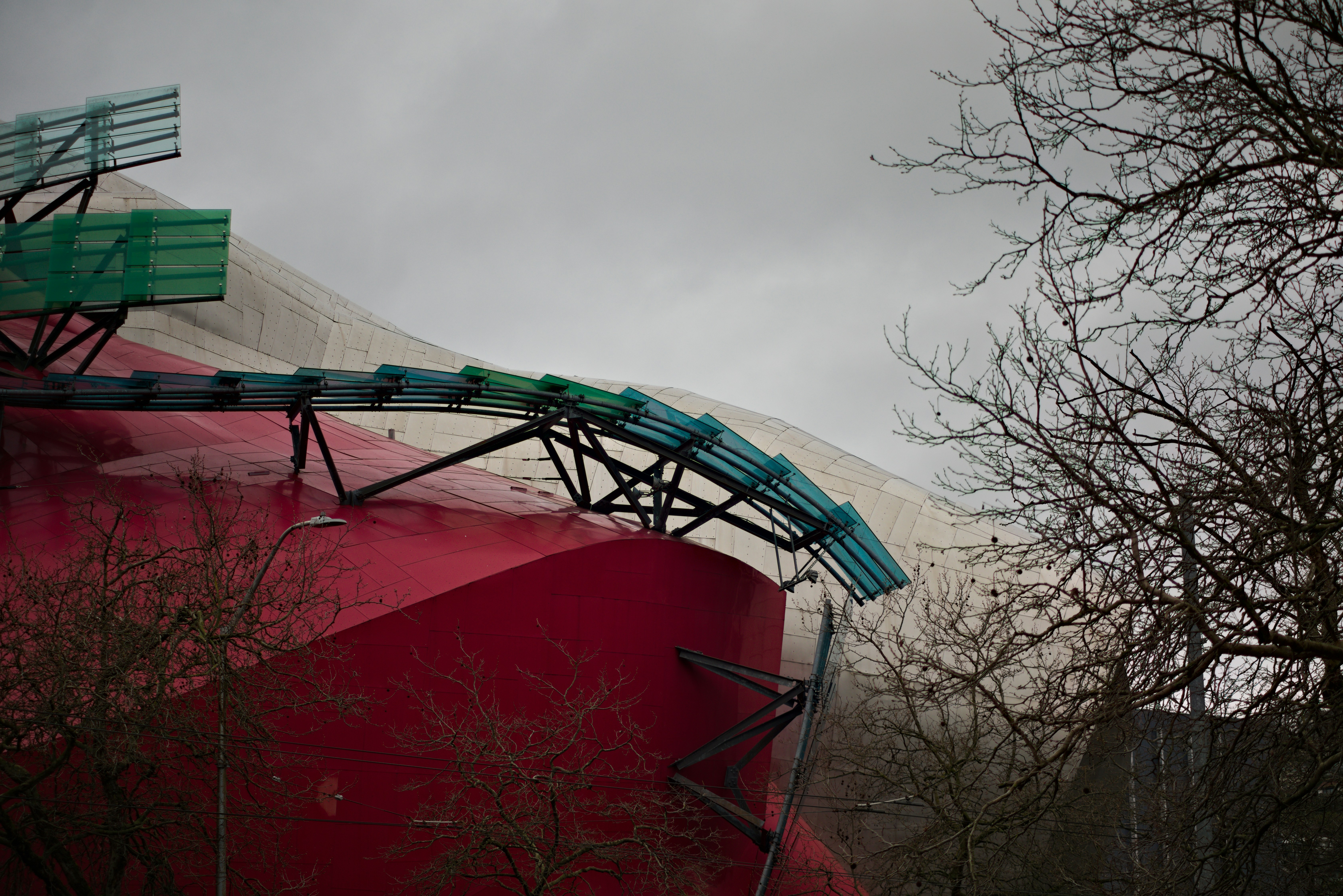 Red Archwork with Cyan Canopy Ribbons Against Bare Trees
