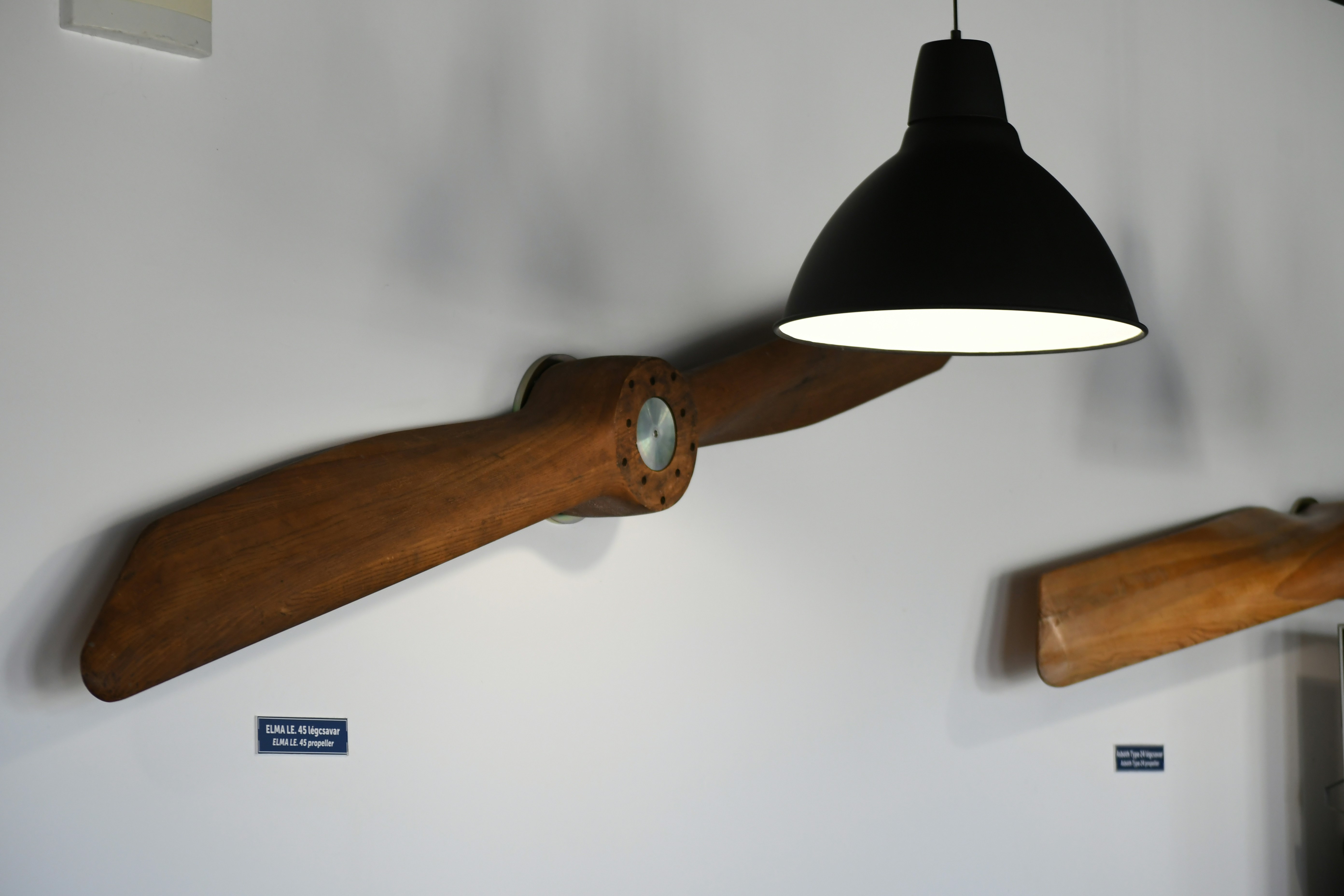 Overhead Light Illuminates Wooden Propellers on Display