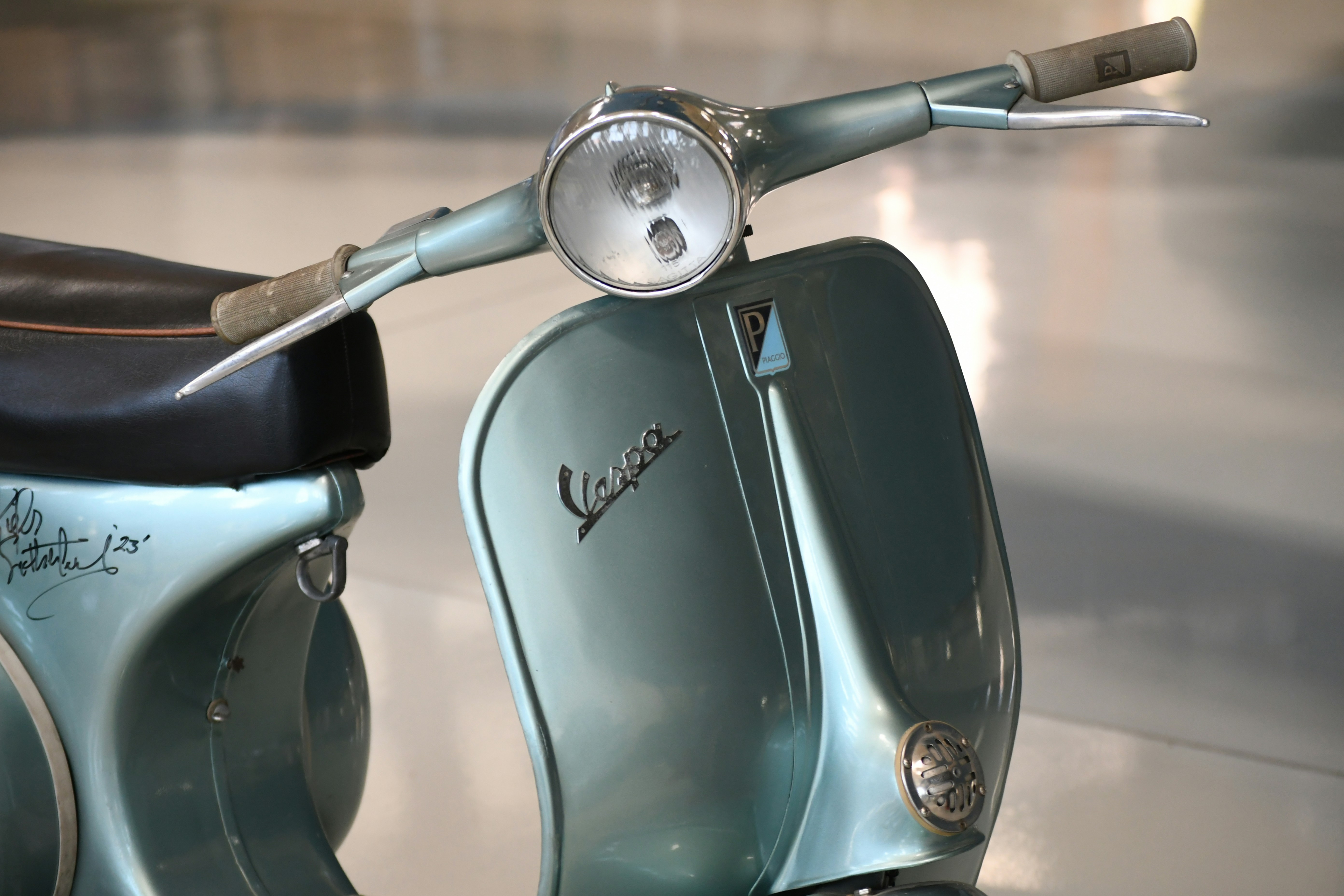 Minted Vintage: A Mint-green Vespa Waiting in the Spotlight