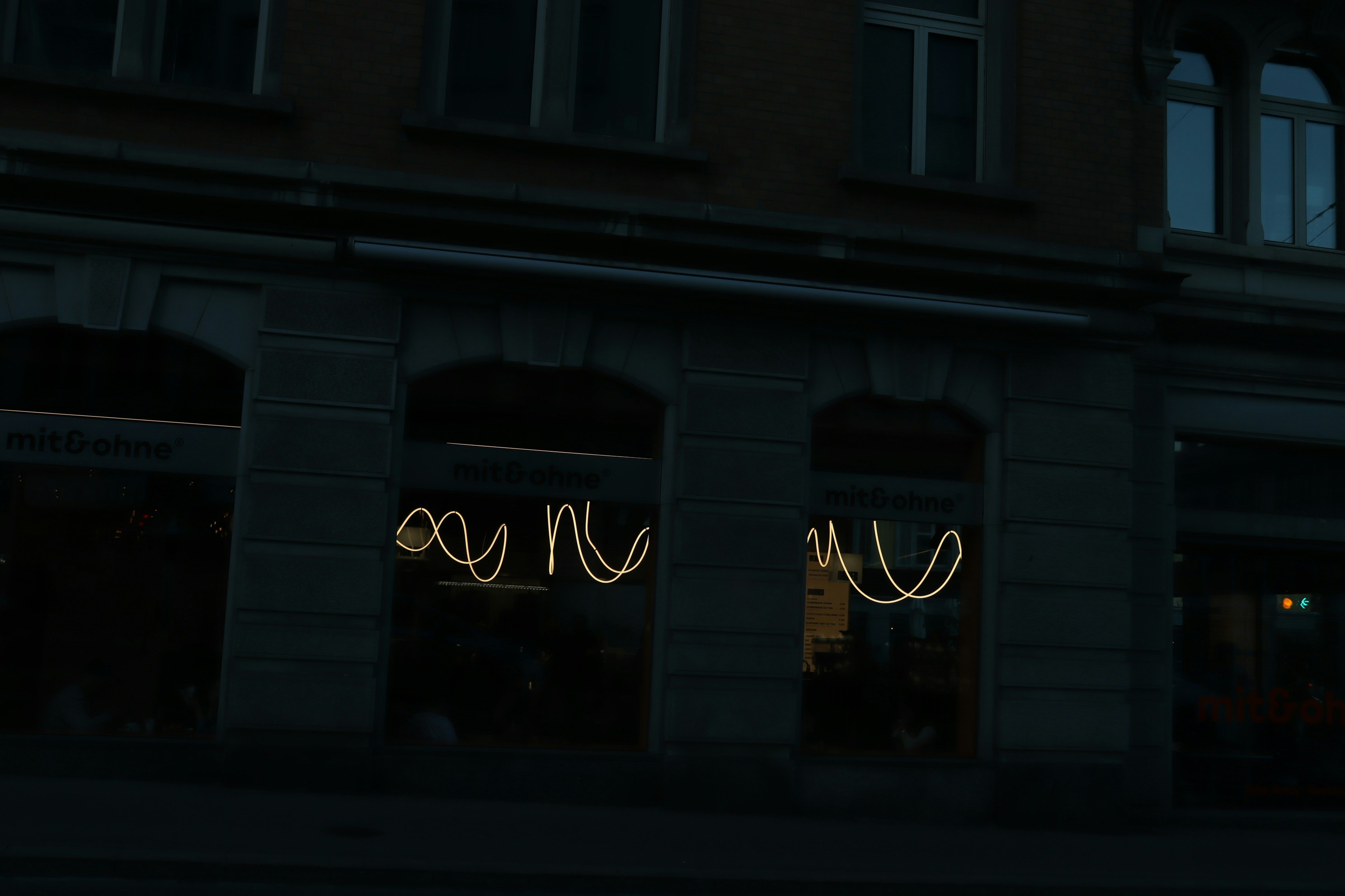 Neon Script in the Shadowed Street