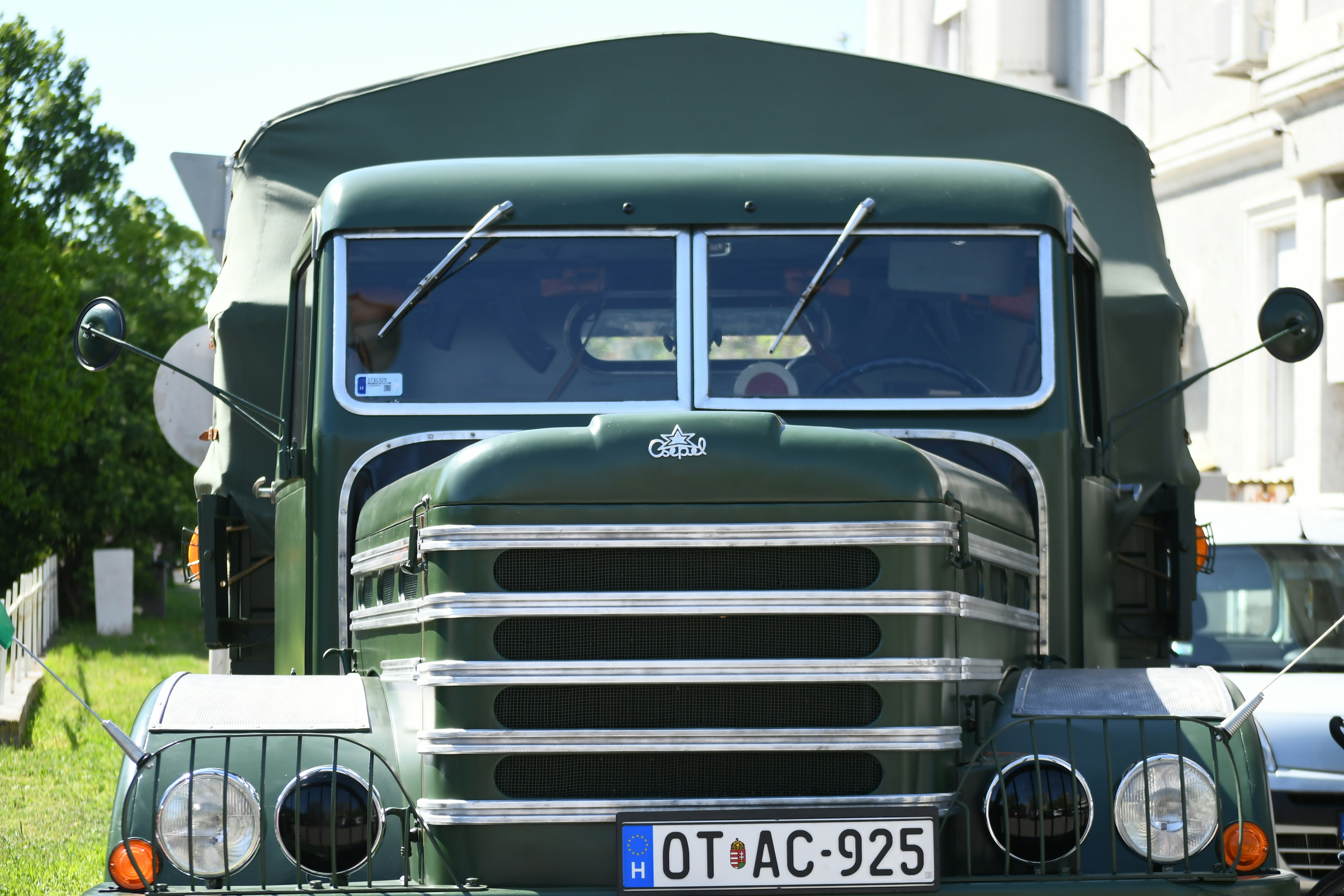Front View of a Classic Green Army Truck with Chrome Grille