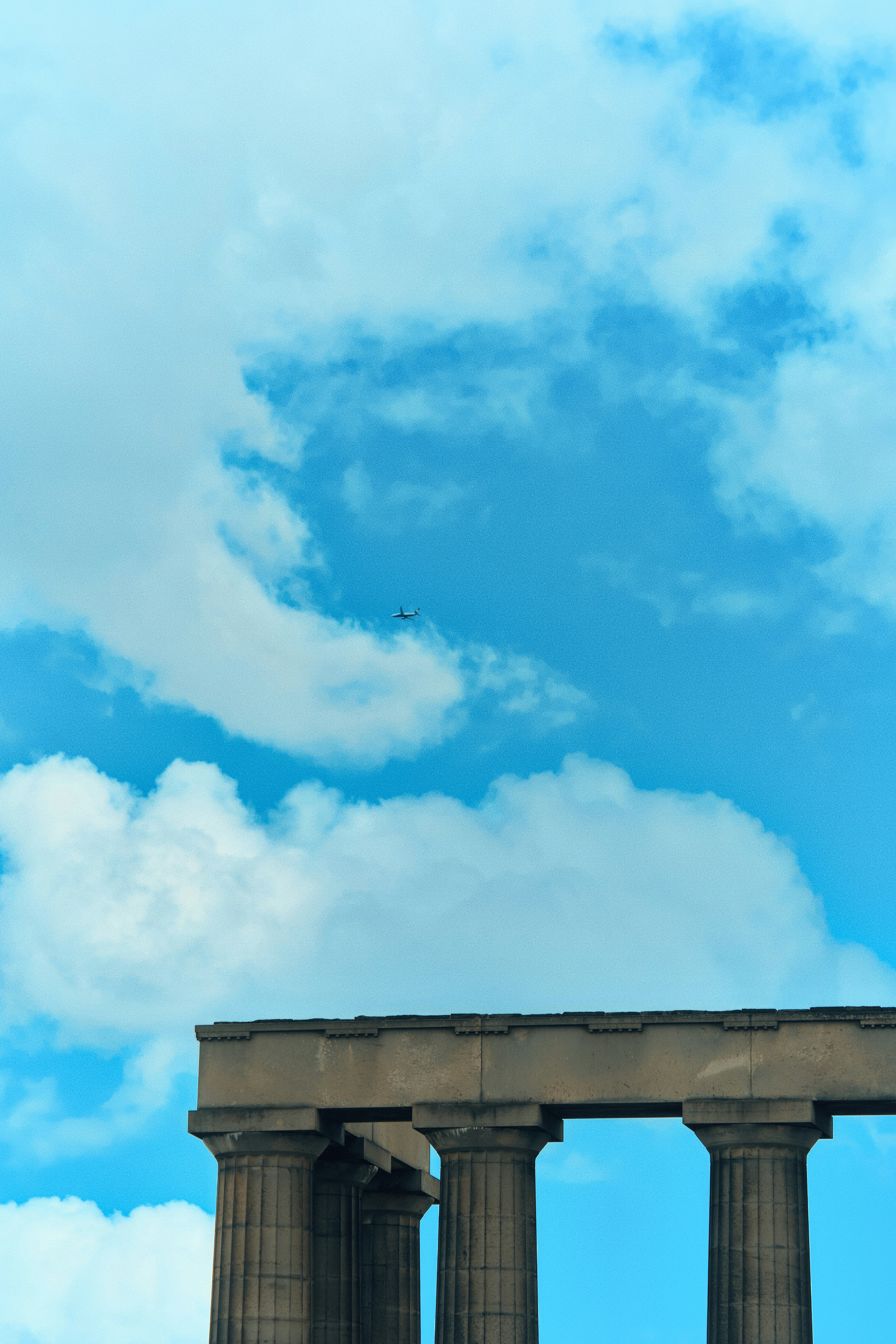 Ancient Columns Stand Beneath a Wide Blue Sky
