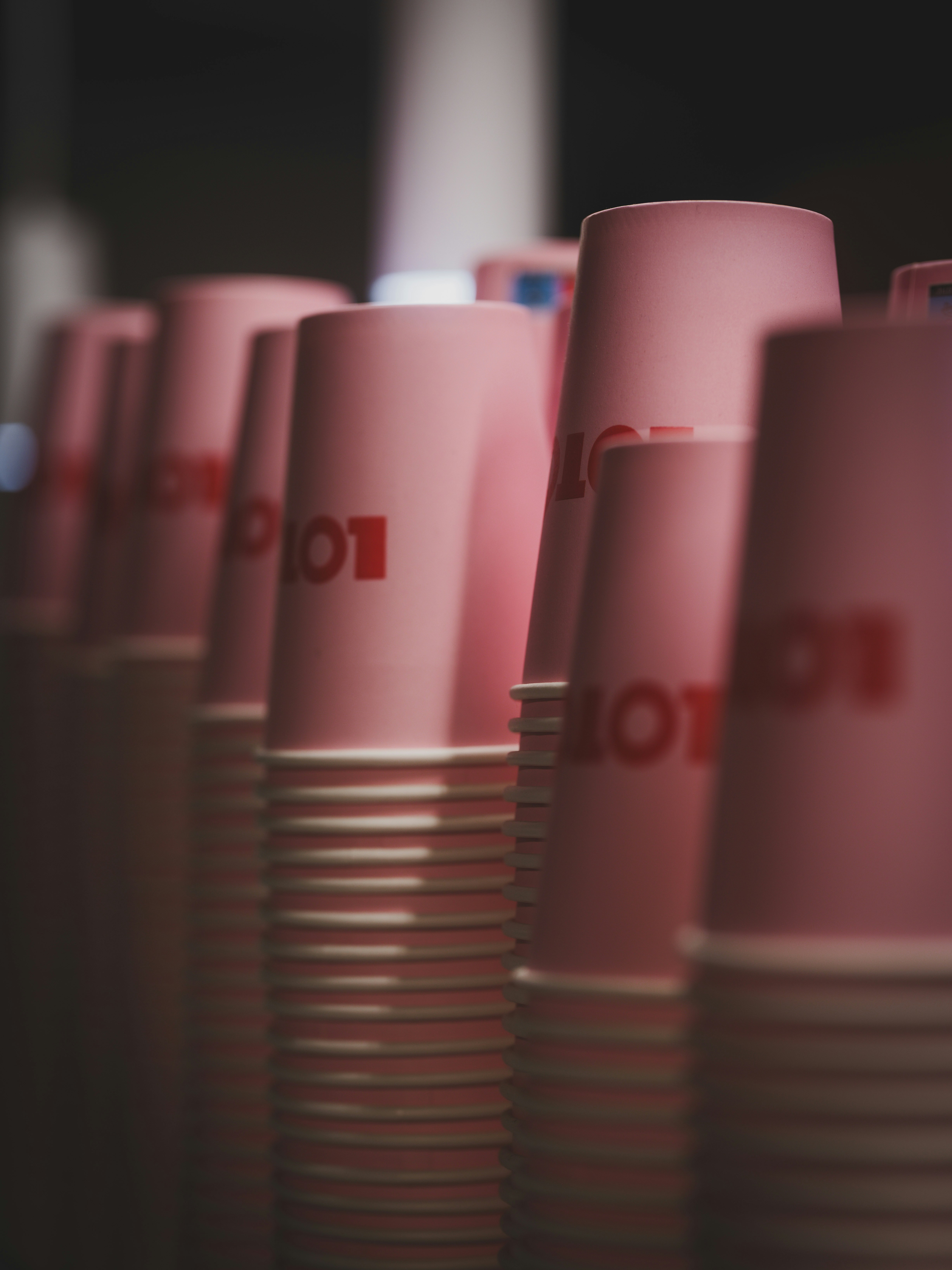 Wine-pink Stacks: A Close-in Look at Repeated Cups in Soft Light