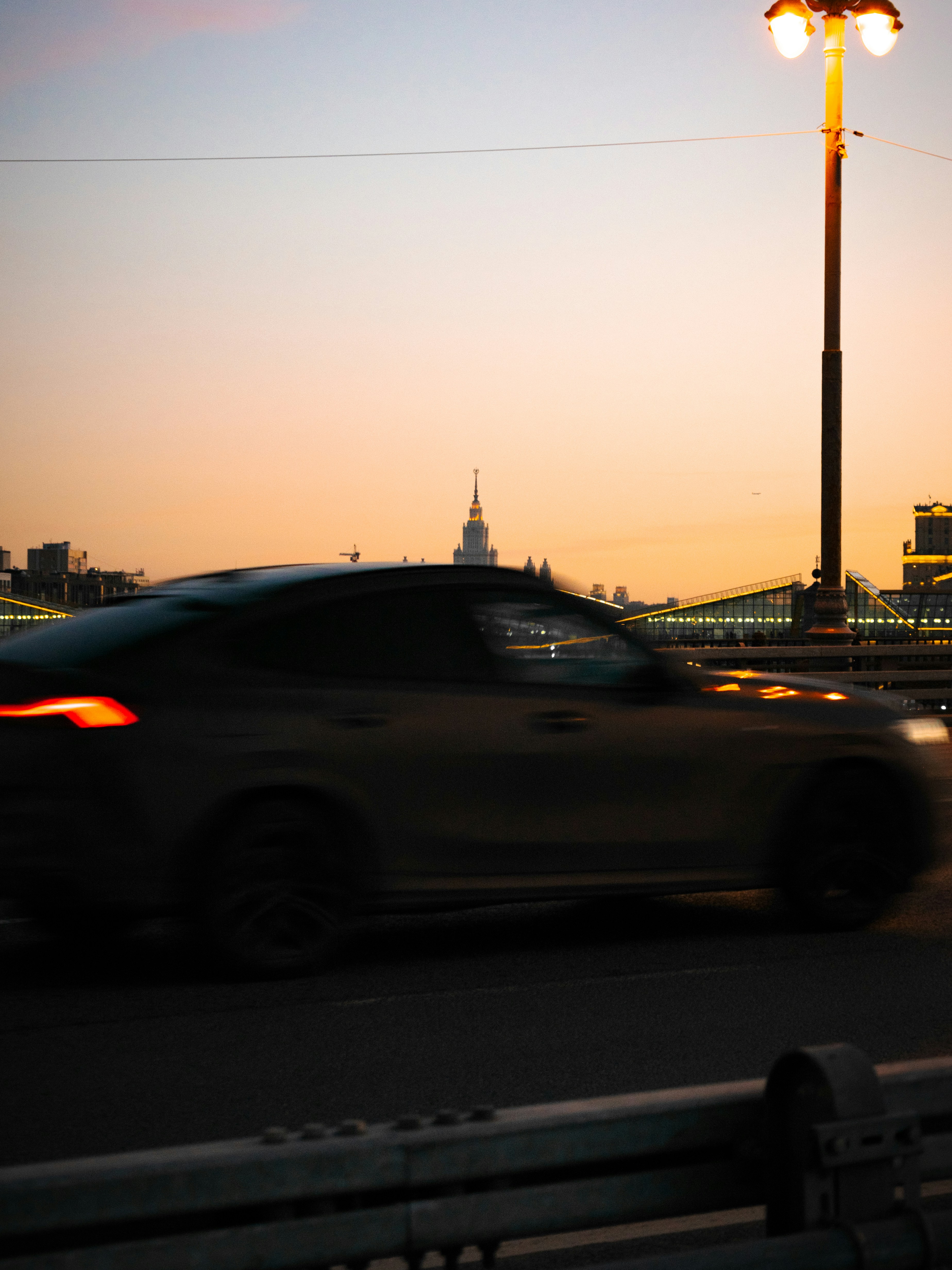 Blurred Midnight Streetcar: City Lights and Skyline in Motion