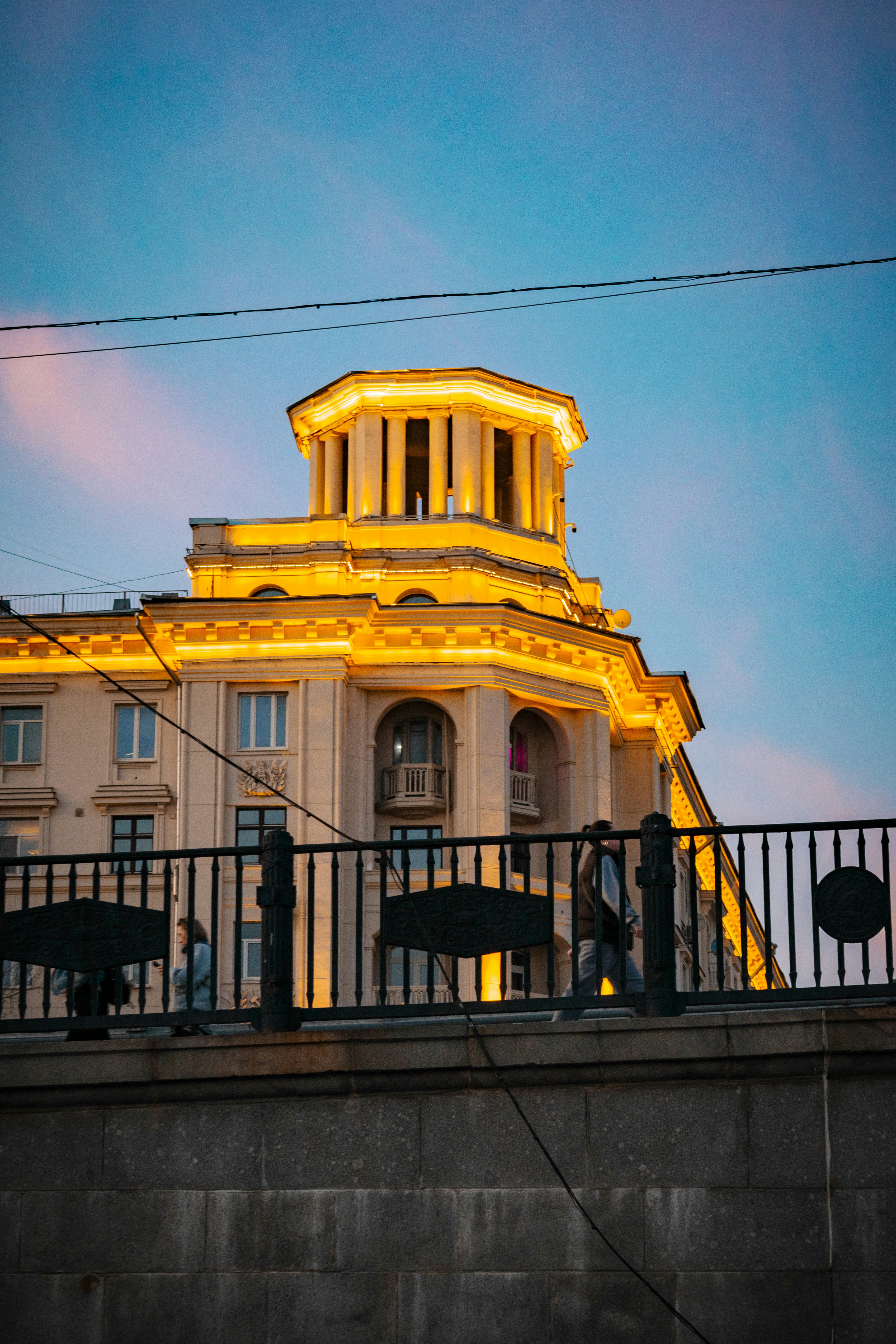 Golden Edges: Illuminated Building Crown Against Night Sky