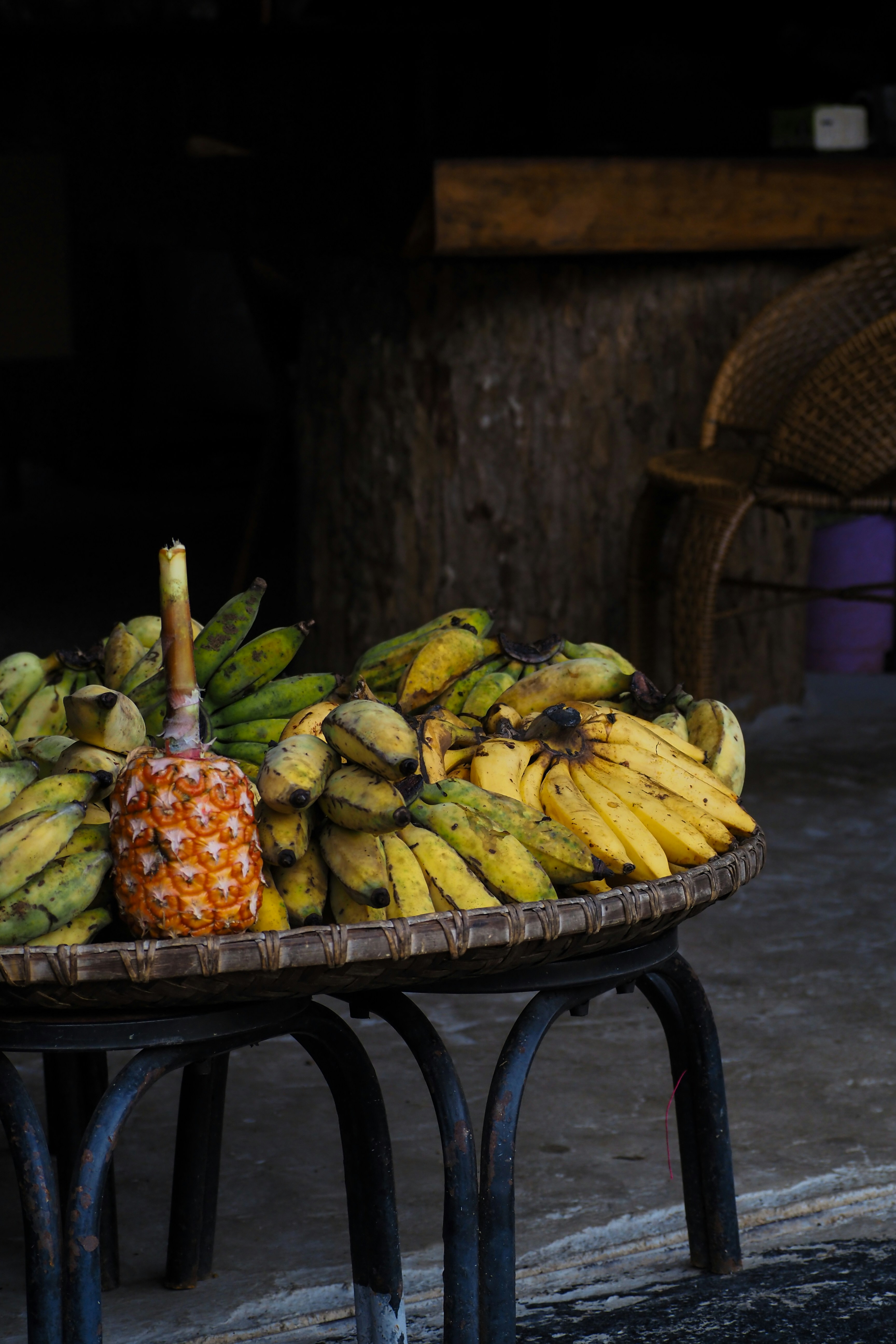 Sun-kissed Pineapple Crown atop a Banana Bounty on a Rustic Table