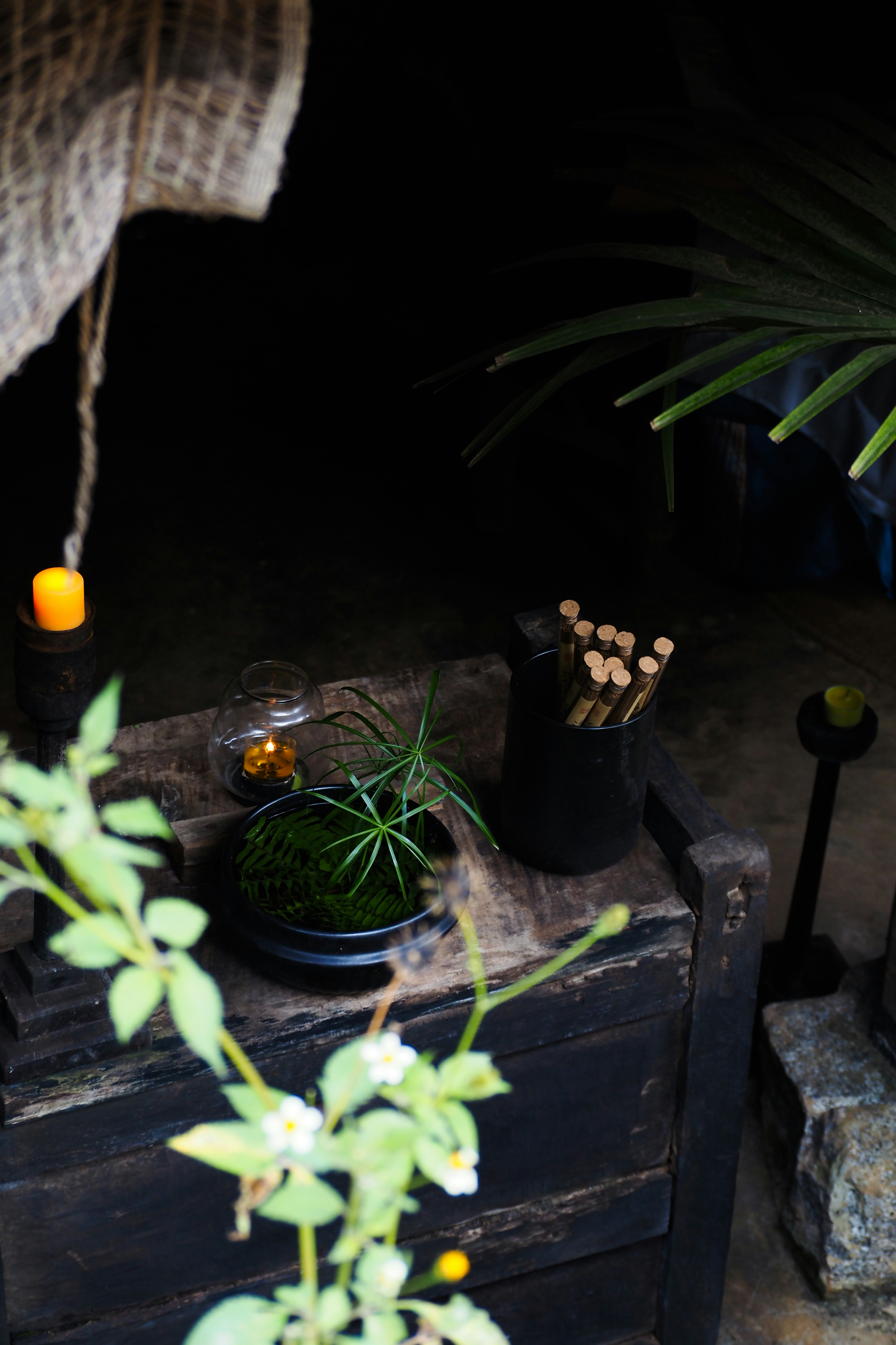 Candlelit Altar with Greenery and Incense in a Rustic Shrine