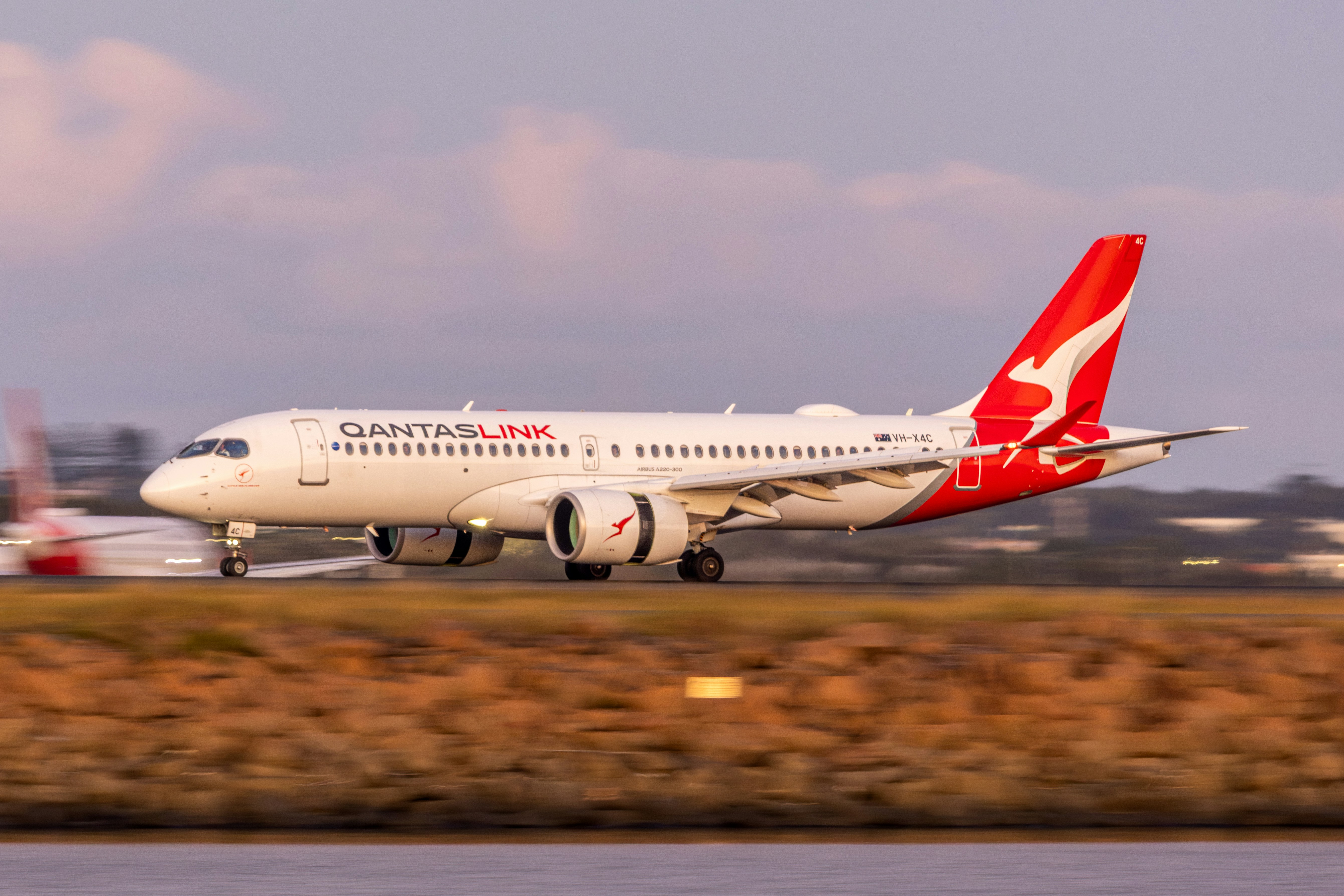 Dawn Rollout: A QantasLink Jet Powers Along the Runway