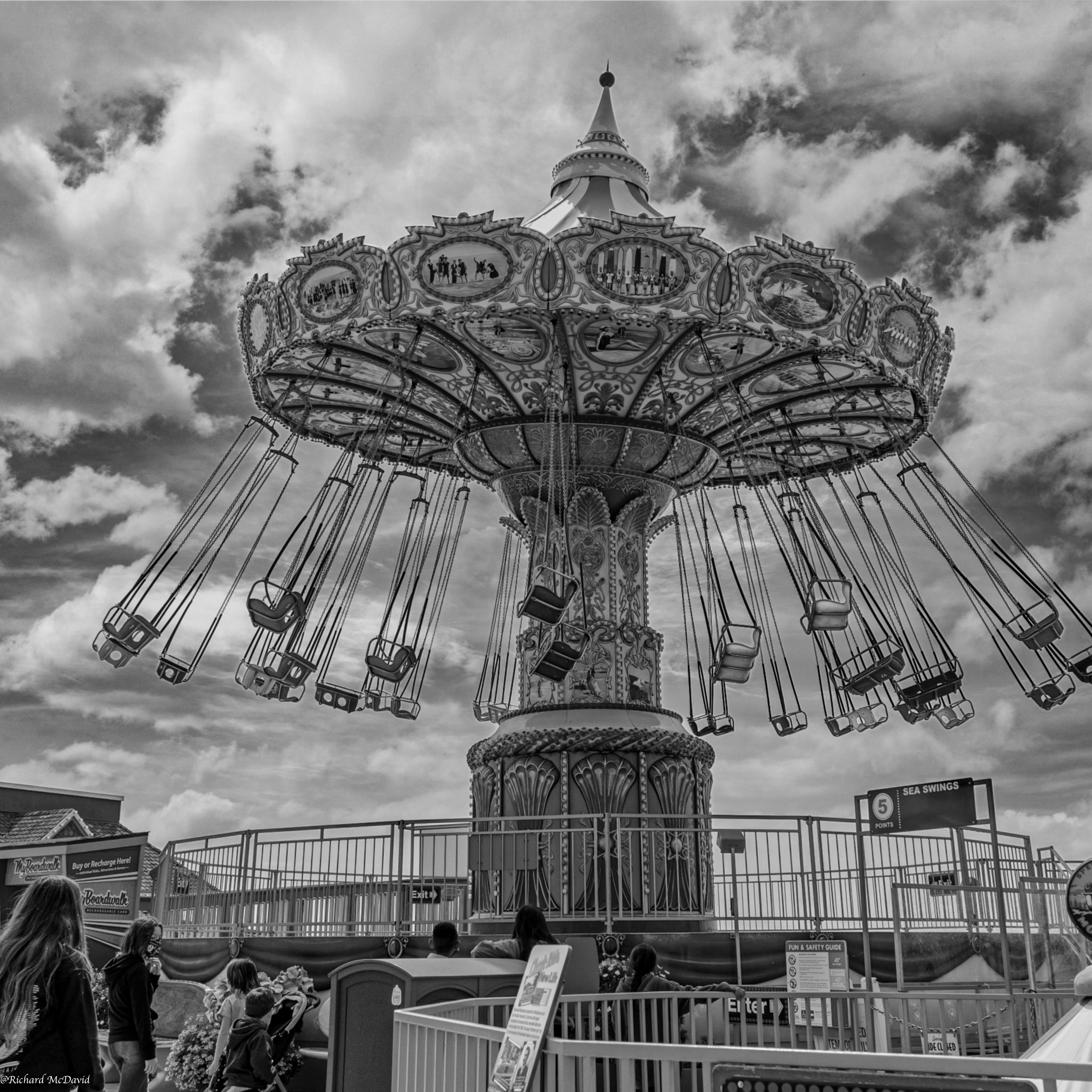 Swinging Carousel Silence: A Monochrome Moment Above the Ground