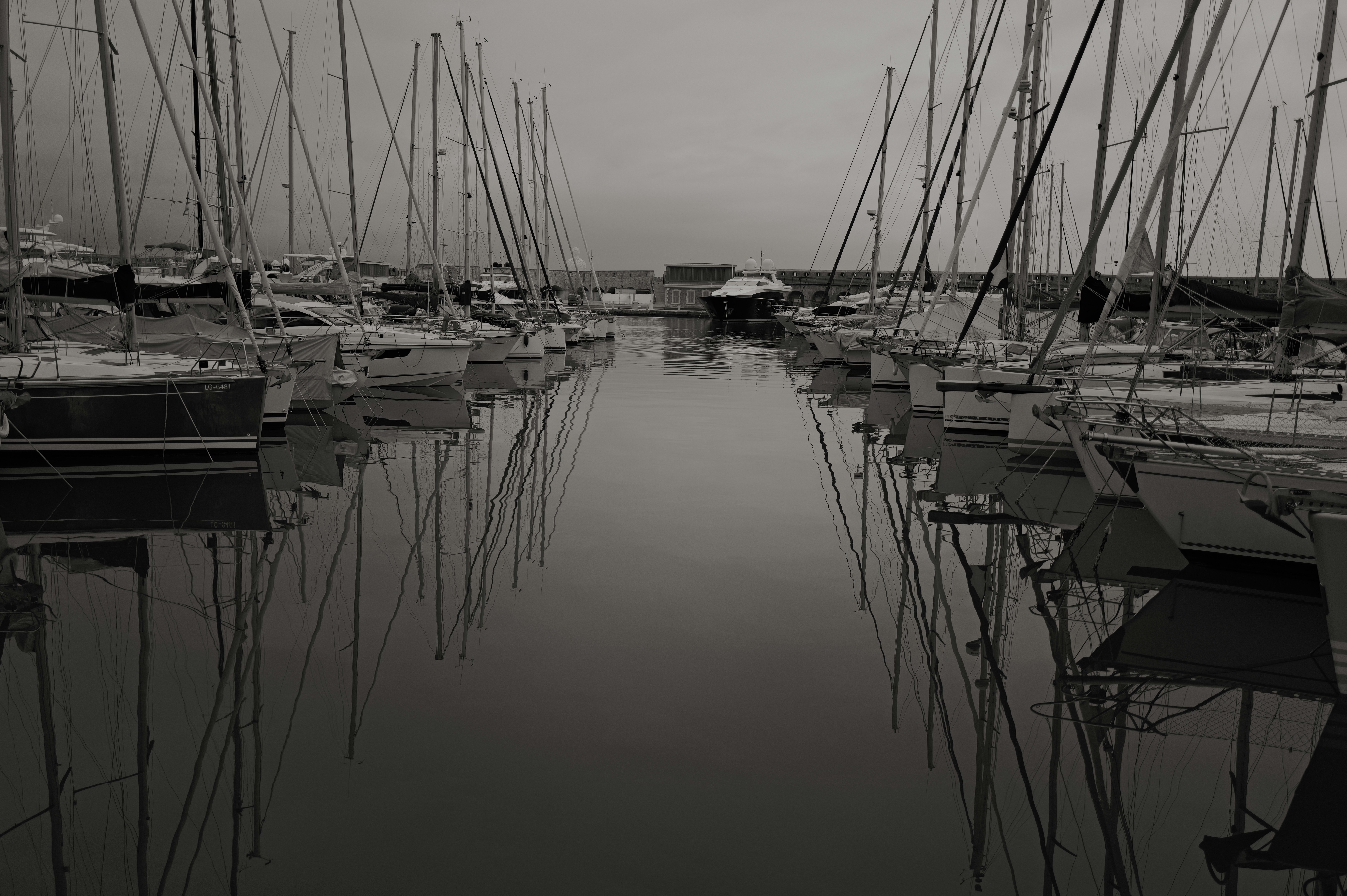 Symmetrical Marina Stillness: Boats Aligning Toward the Horizon