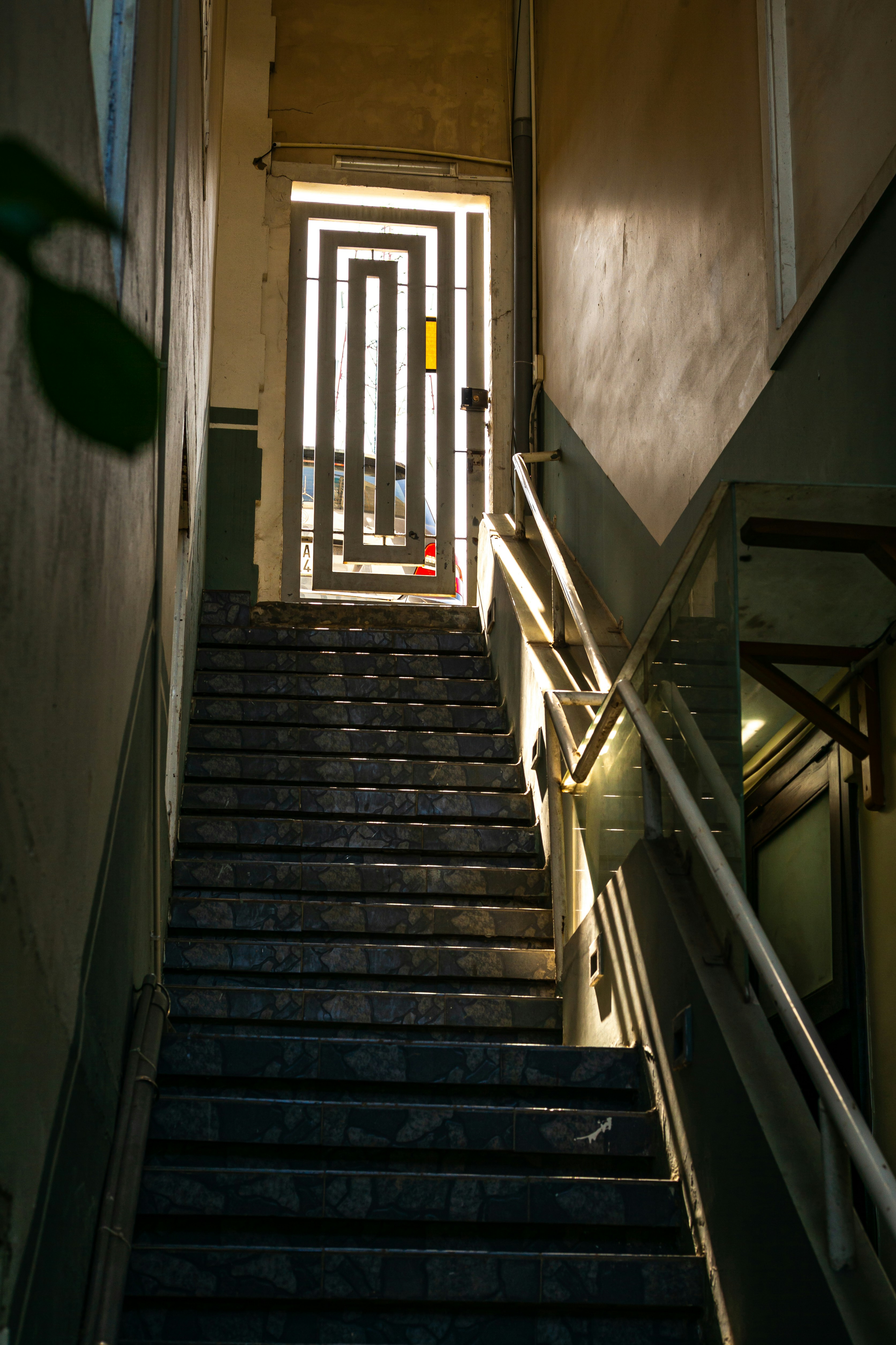A Maze of Light: Stairwell Framed by Geometric Gate