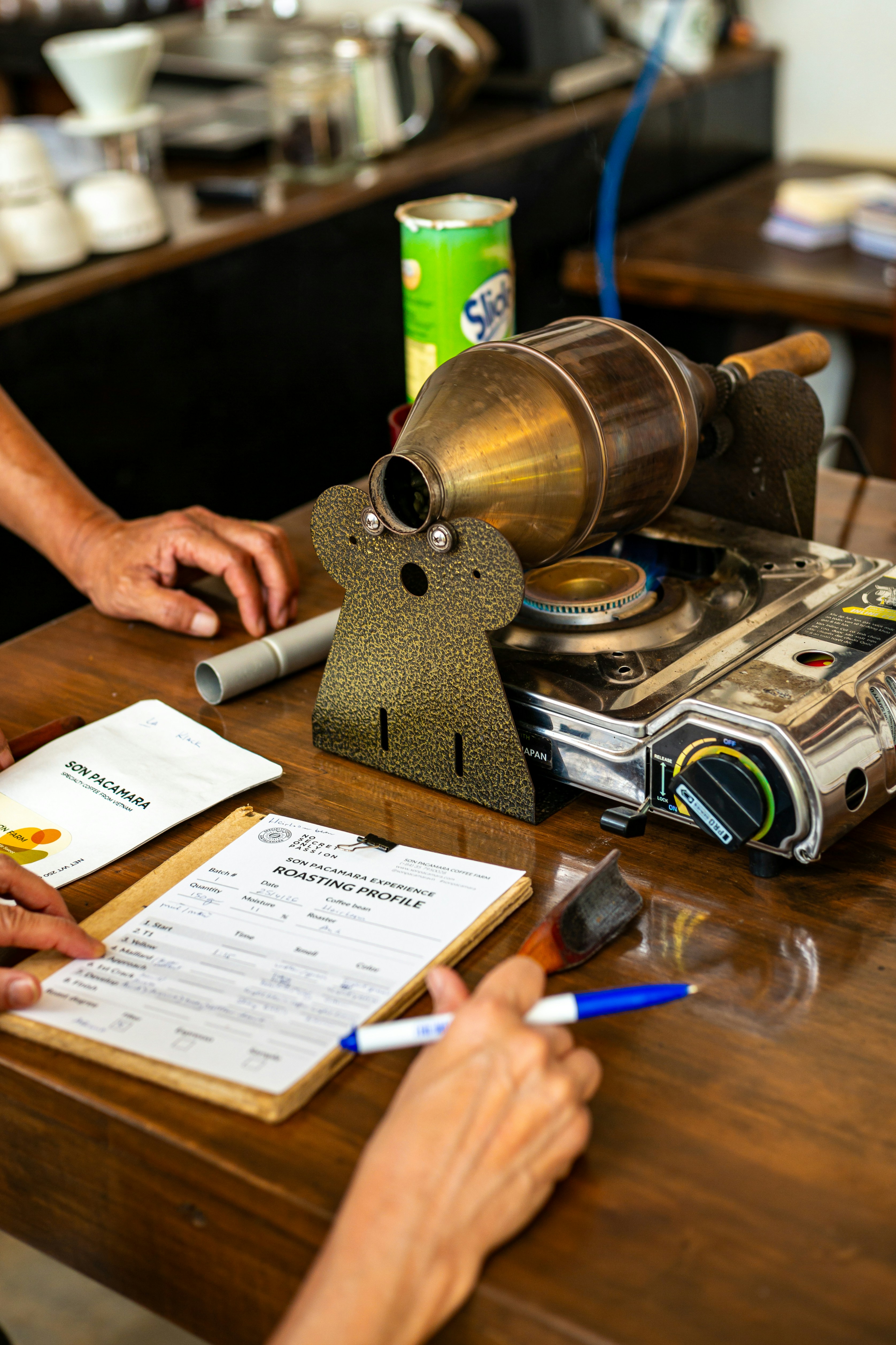 Steam-powered espresso: a barista’s workstation with a vintage roaster in action