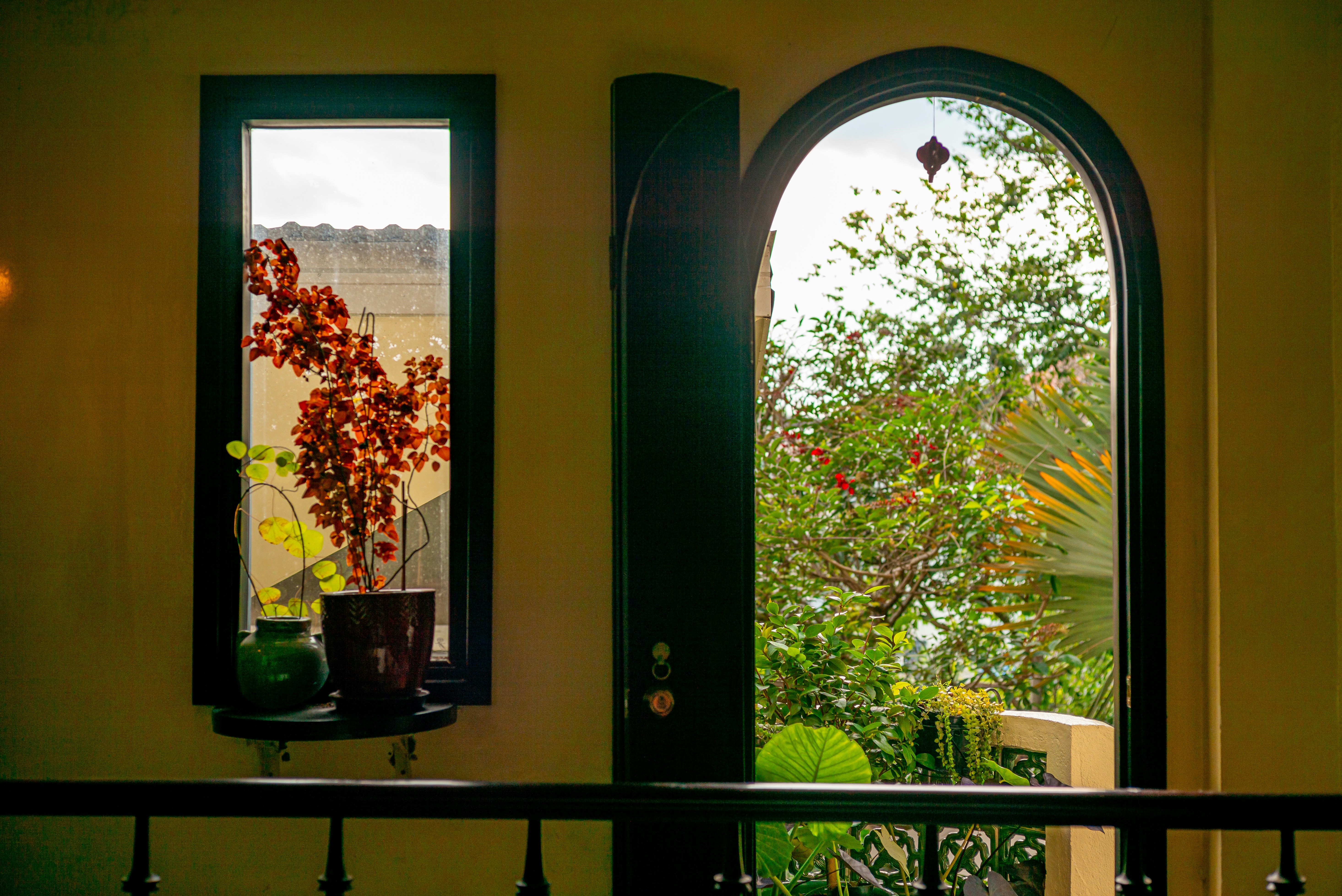 A Quiet Doorway Framing a Green Courtyard