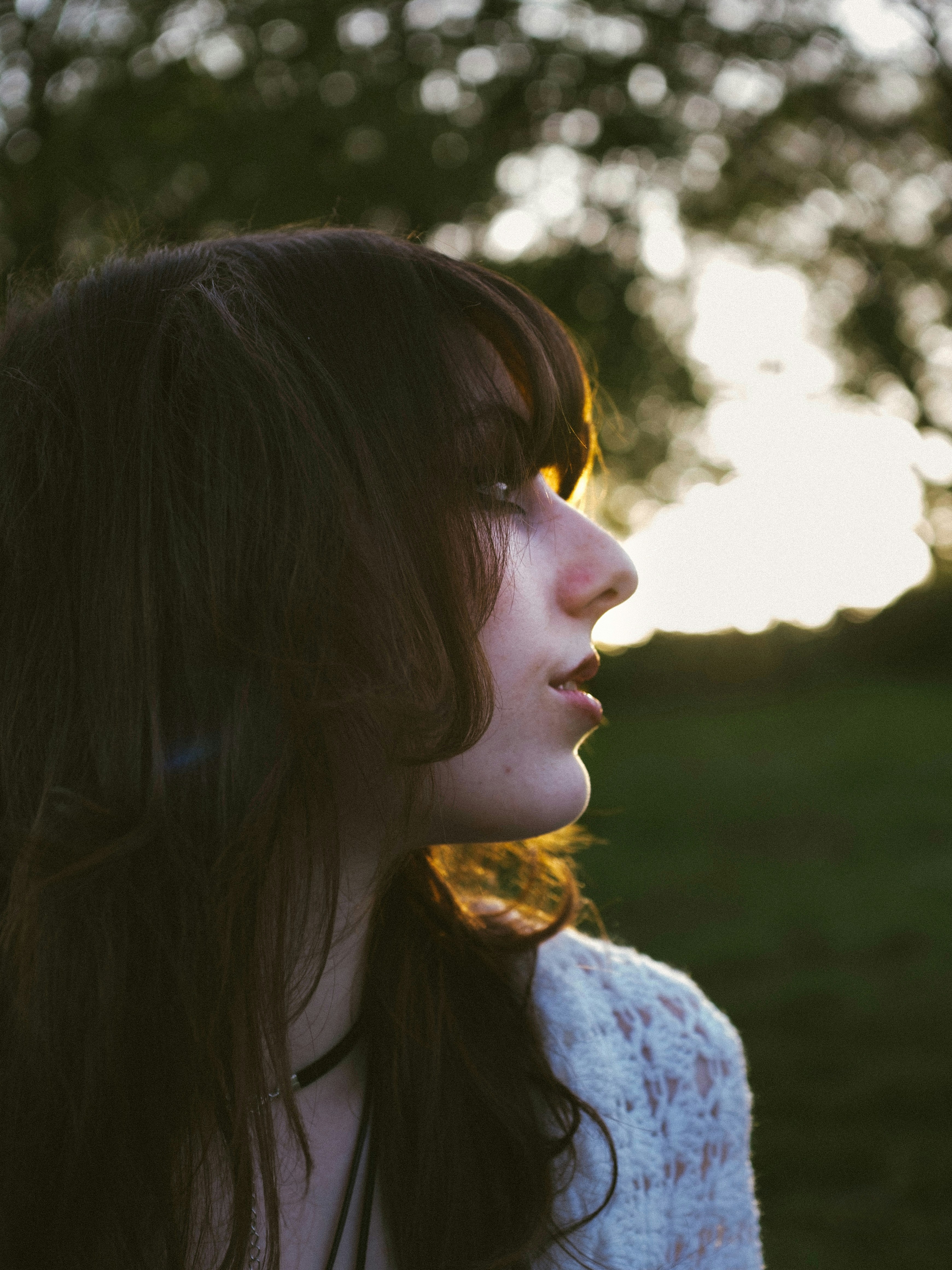 Softly Lit Profile: Sunlit Hair and Contemplative Gaze