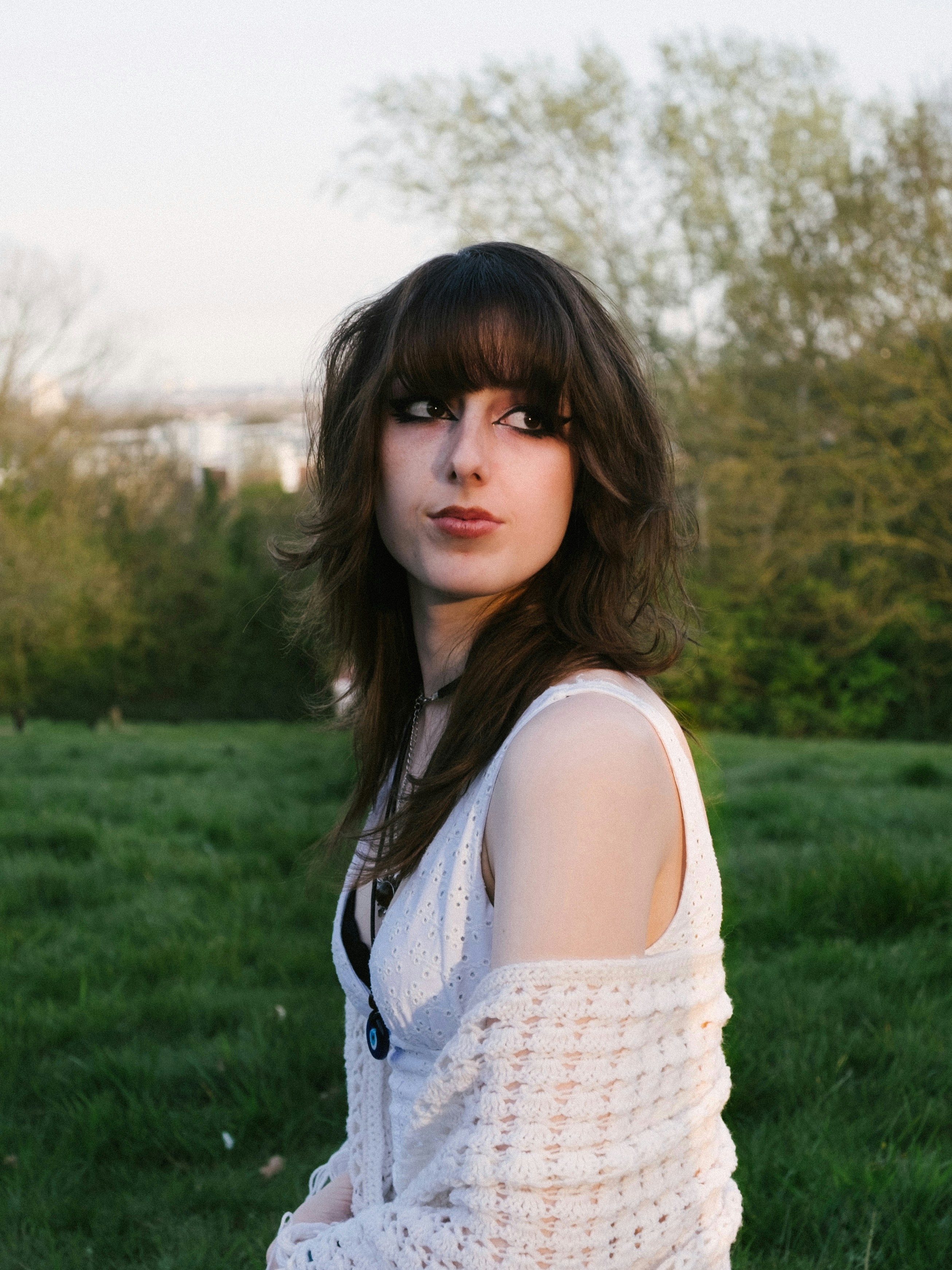 Soft Evening Gaze: A Portrait in a Green Clearing