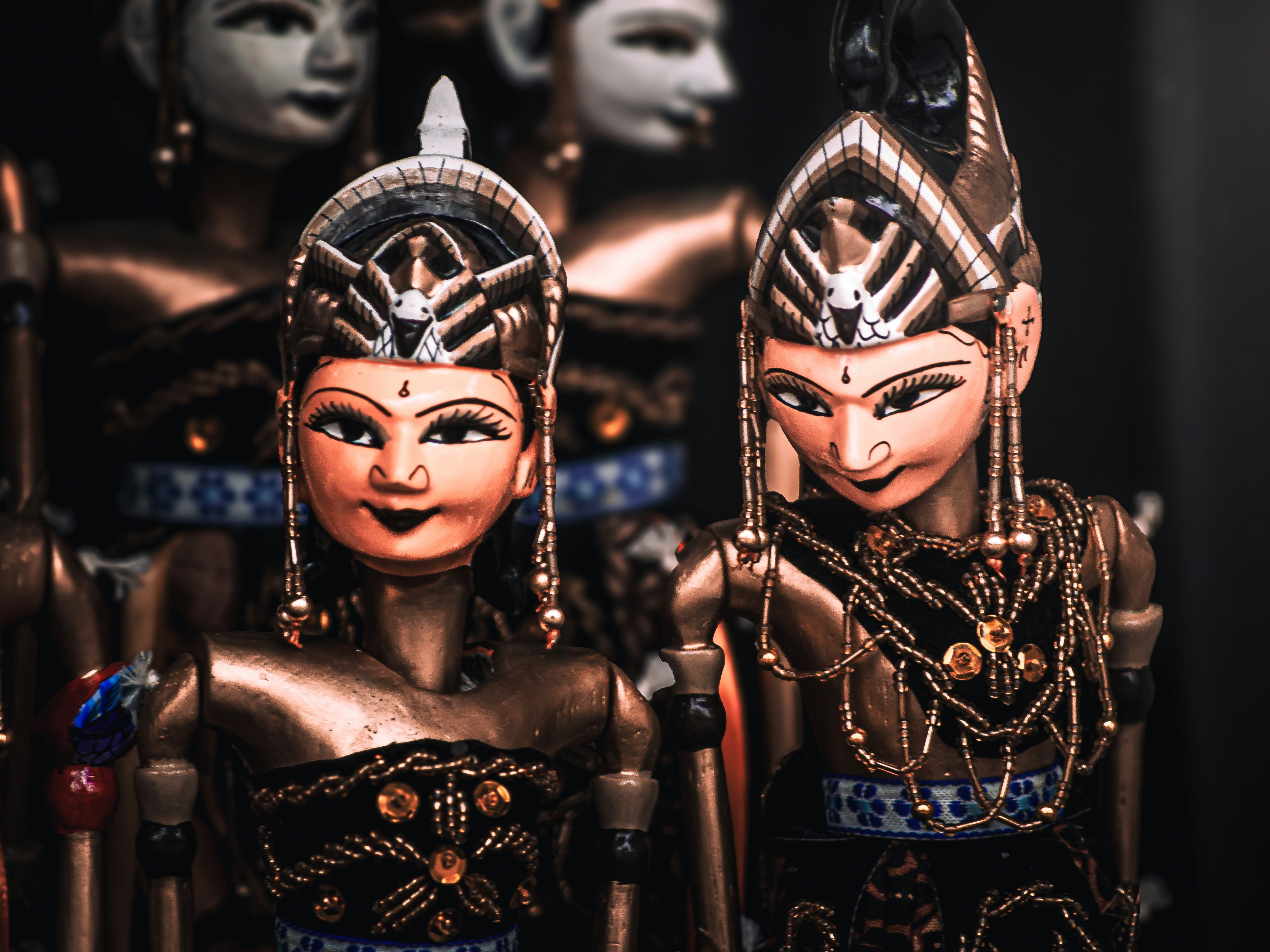 Regal Wooden Faces: Two Artisanal Puppets in Focus