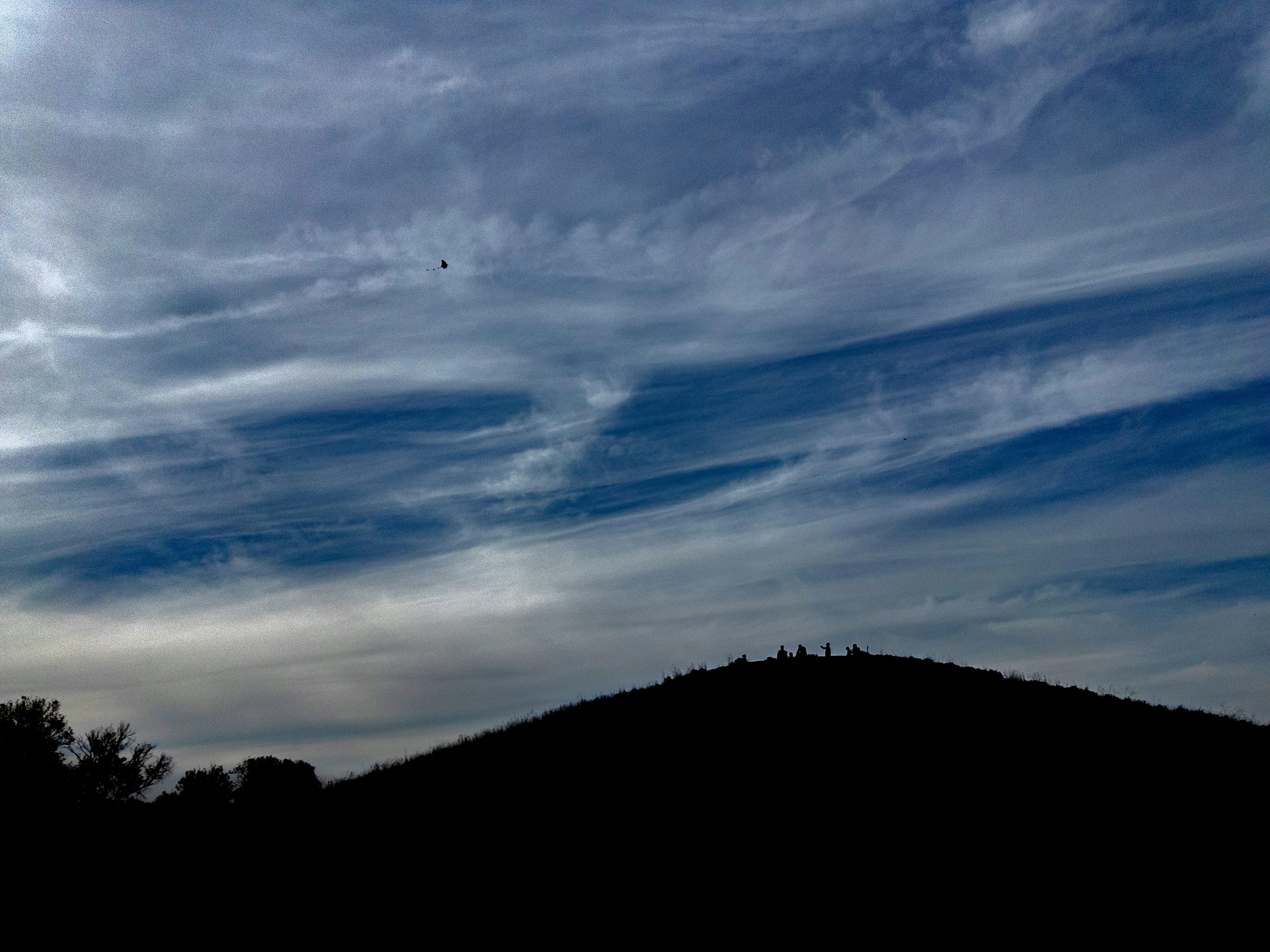 Silhouette Crest Beneath a Tapestry Sky