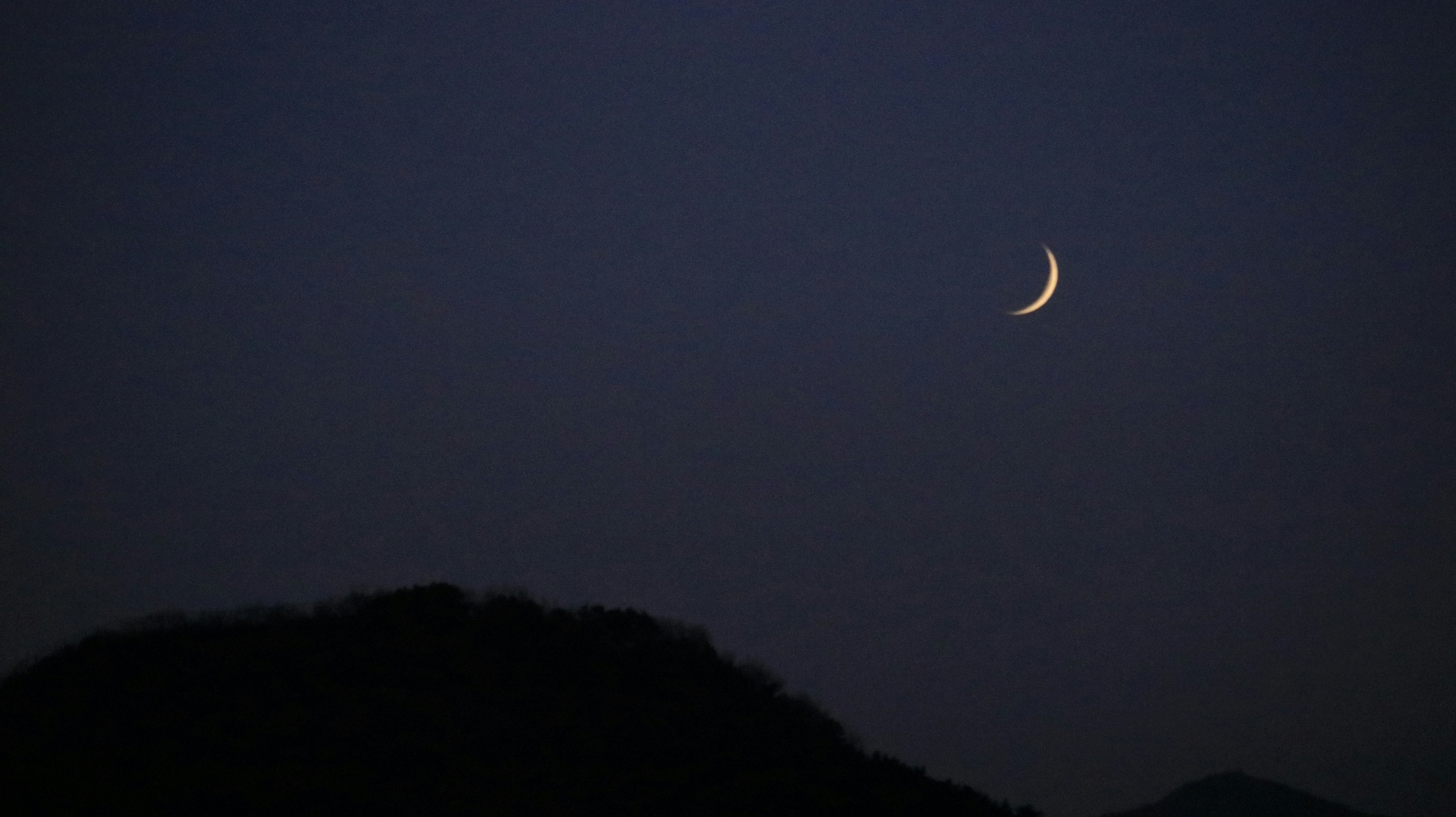 Moonlit Crescent Above Quiet Hills