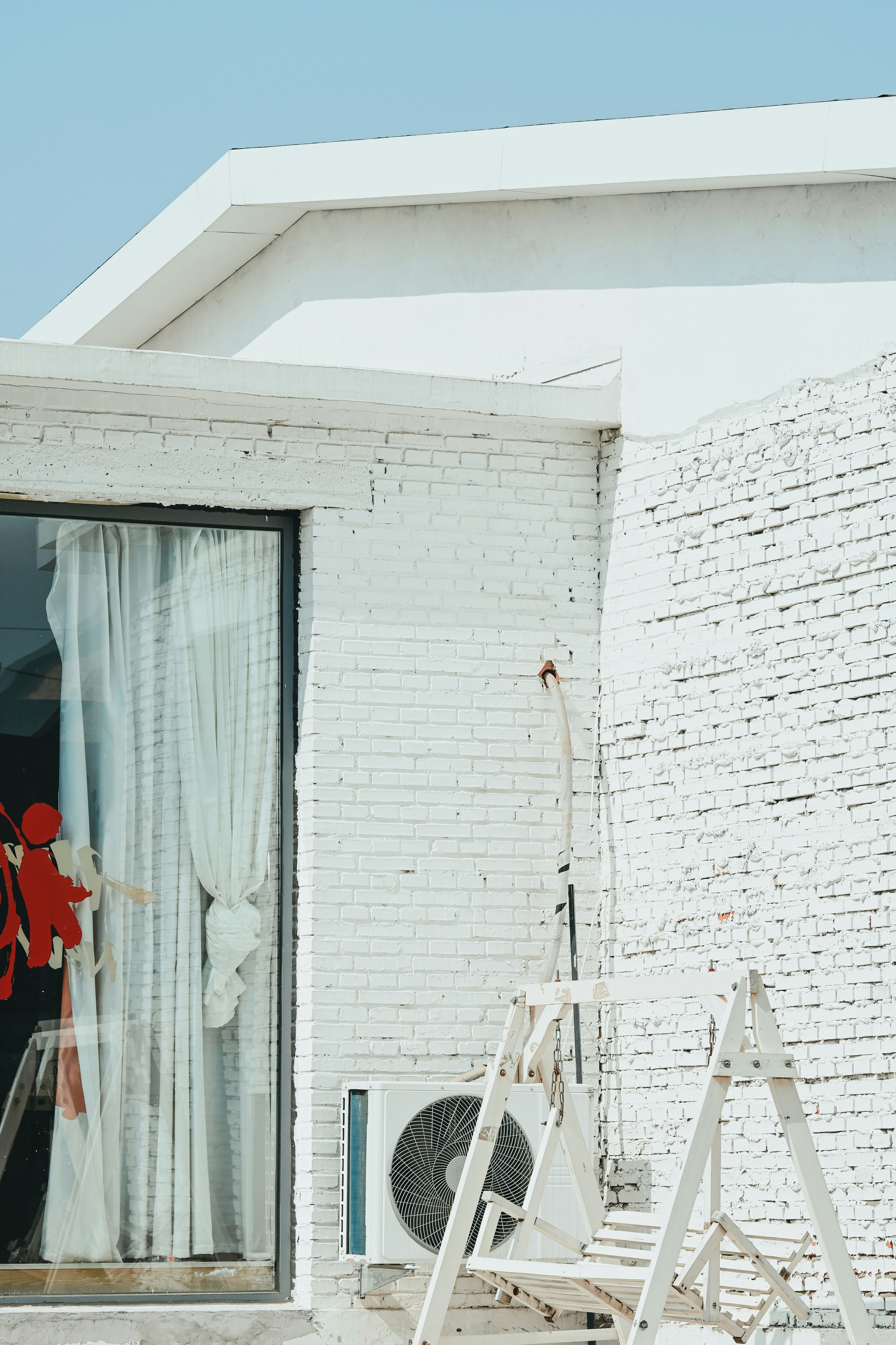 White Brick Terrace and Glass Door in Bright Wall Scene
