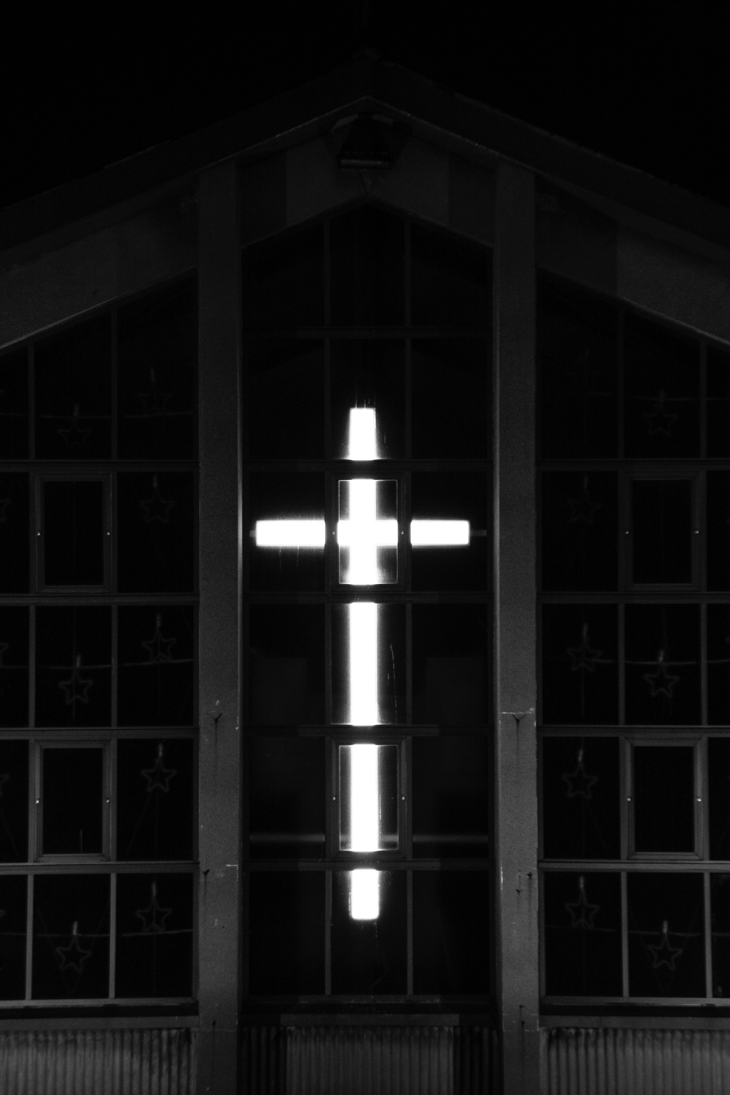 Glowing Cross: Silent Stained Glass in the Dark Cathedral