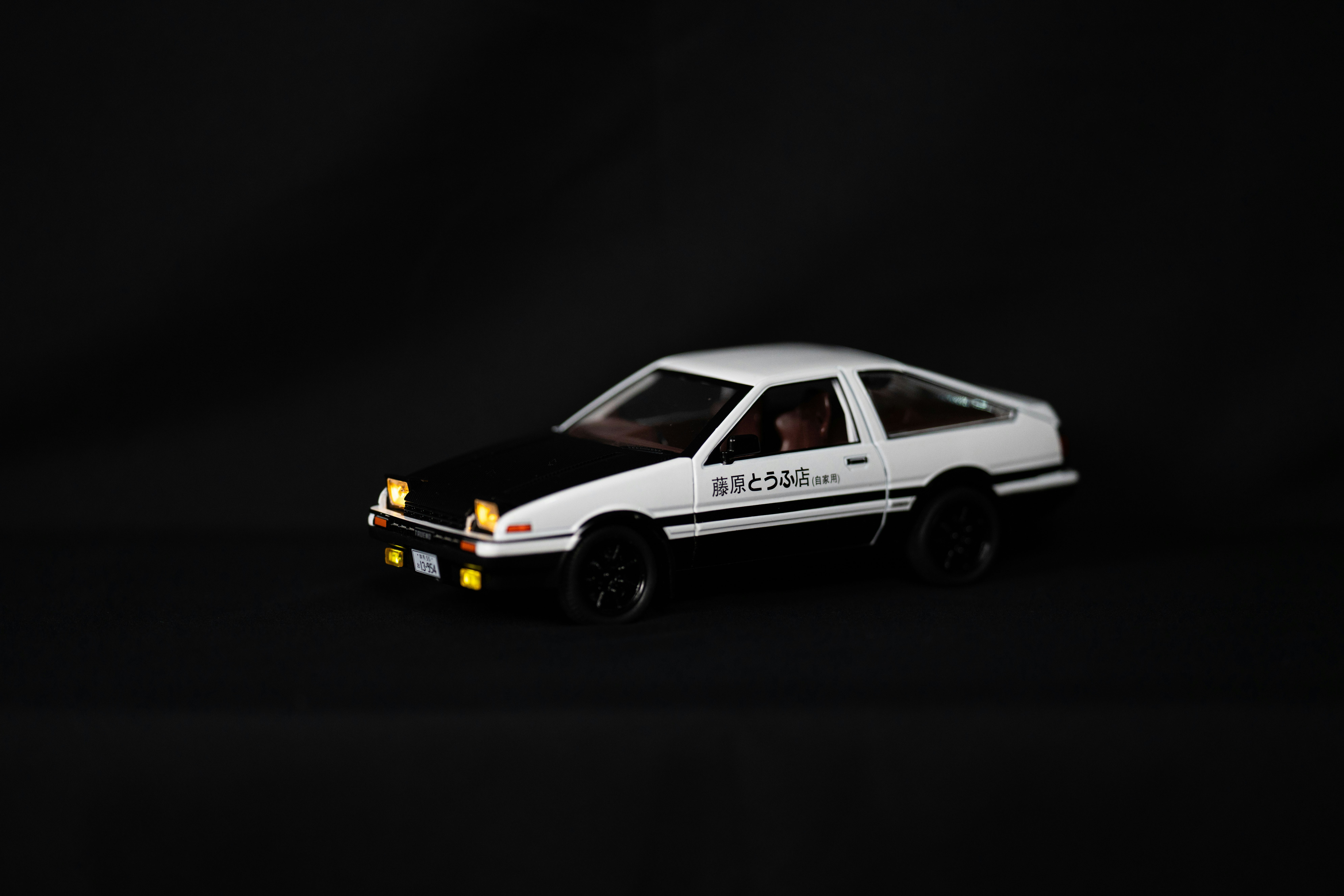 Miniature sedan under a velvet black sky