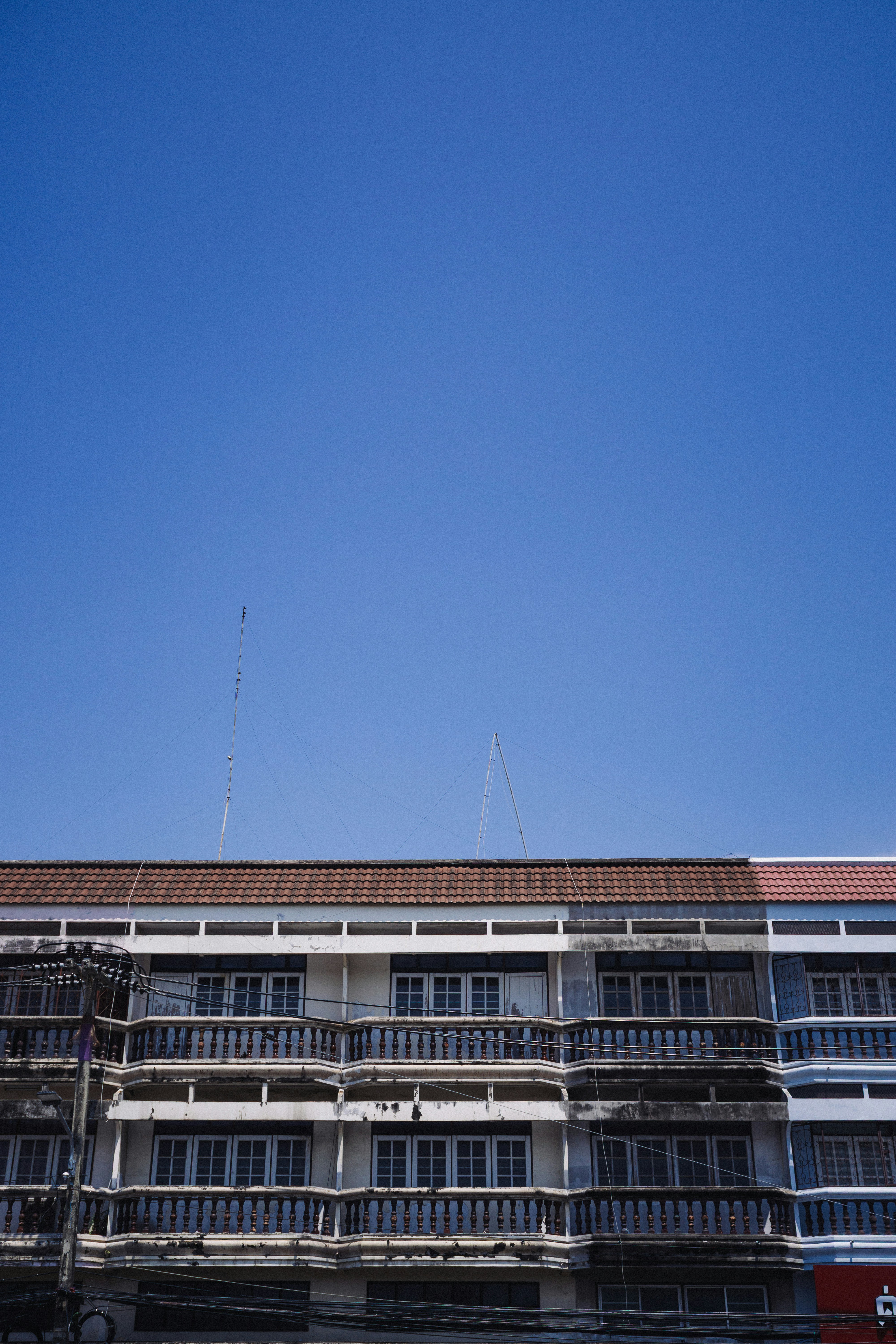 Skyward Lines: Urban Terrace Beneath a Clear Blue Vantage