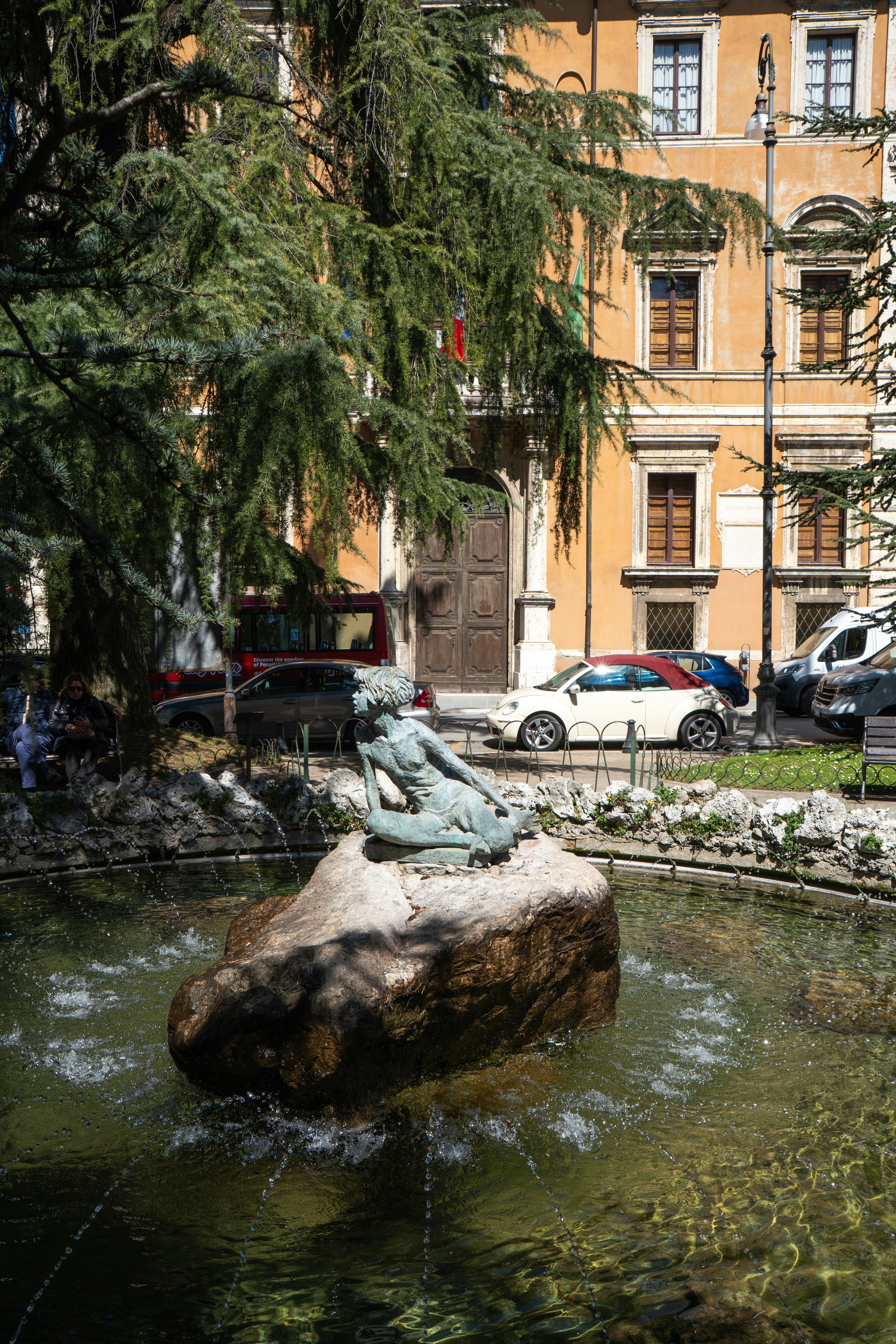 Stone Mermaid in the Circle: A Fountain Under Autumn Facades