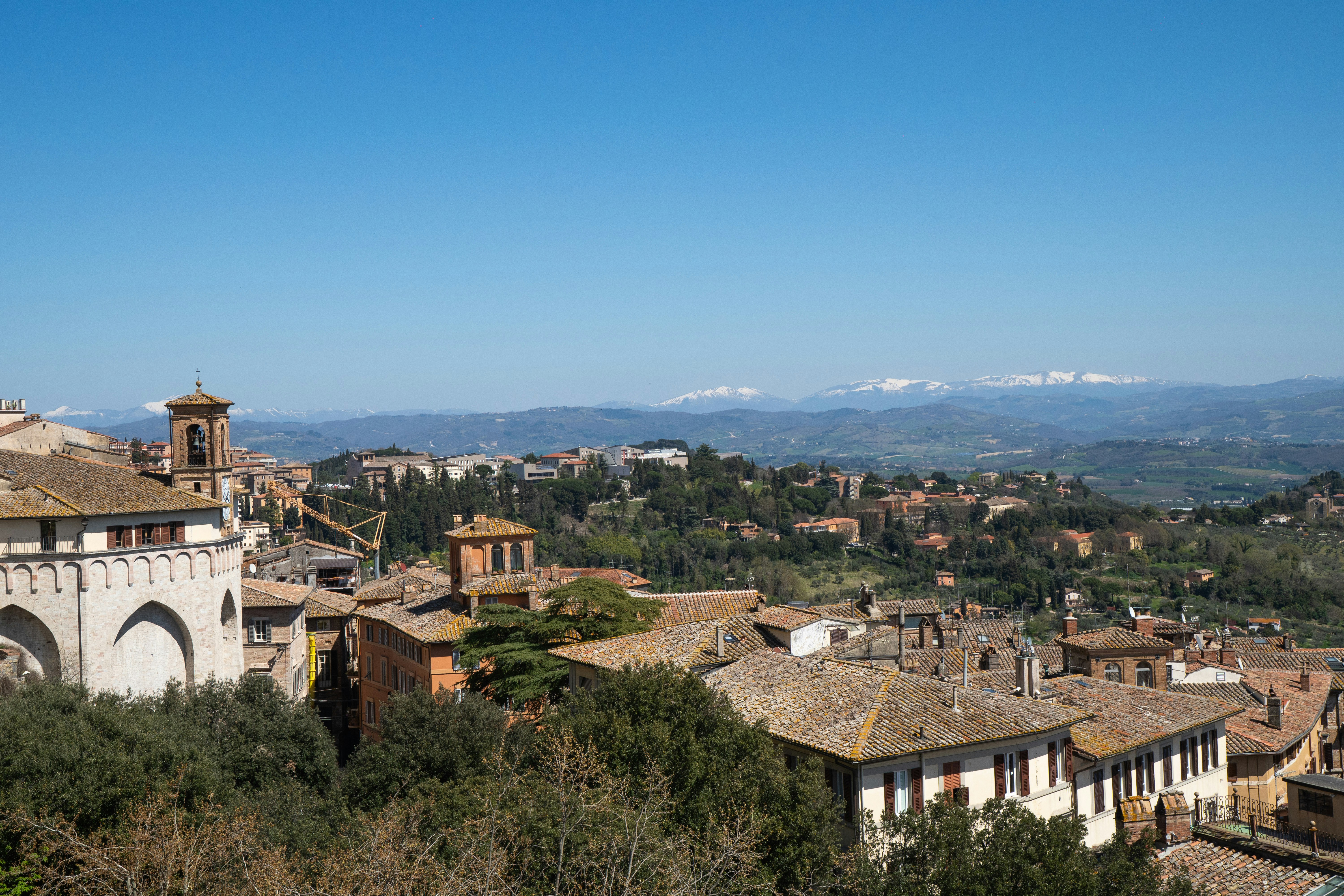 Sunlit hill town: terracotta roofs under a clear sky