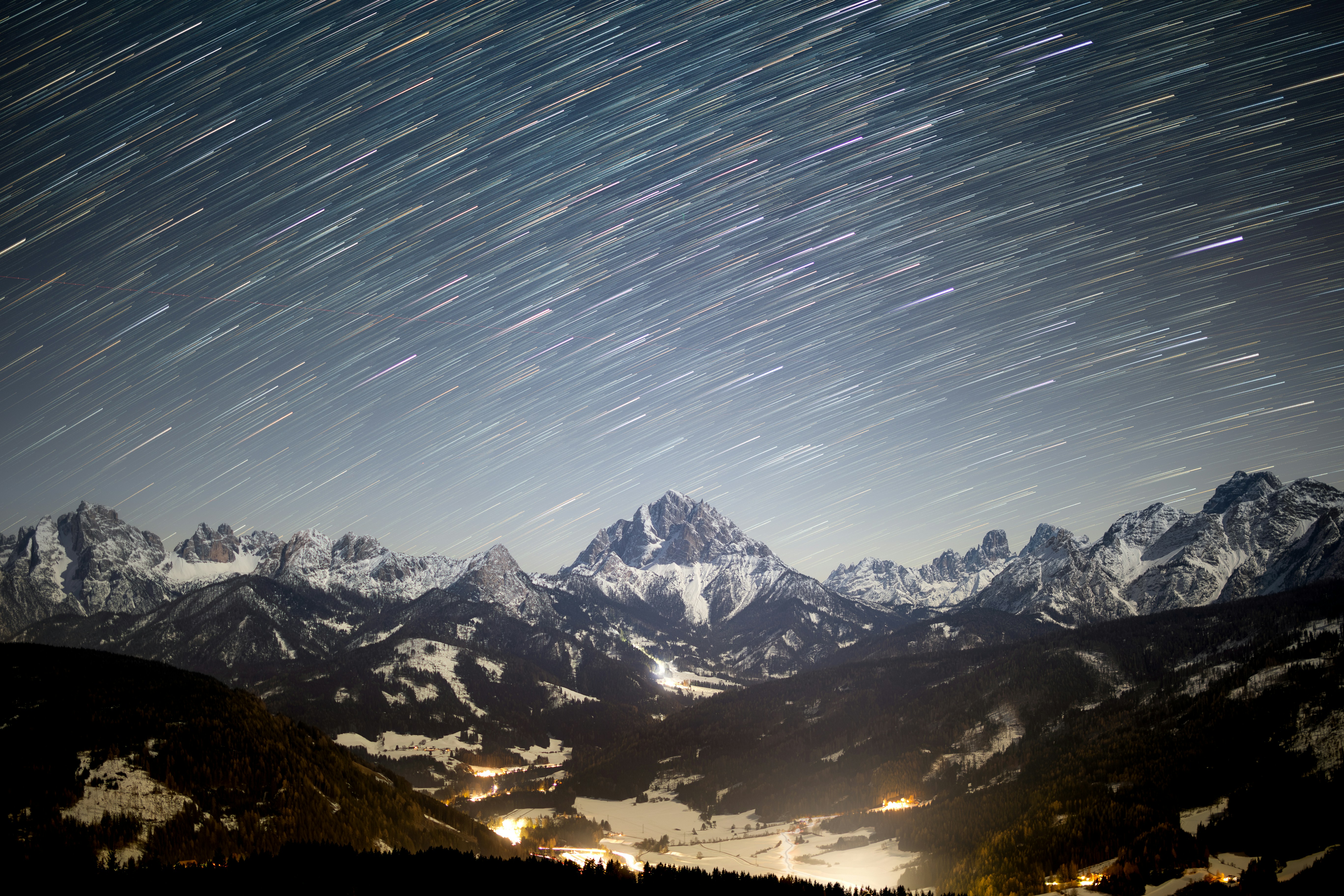 Moonlit Peaks under Cycling Stars