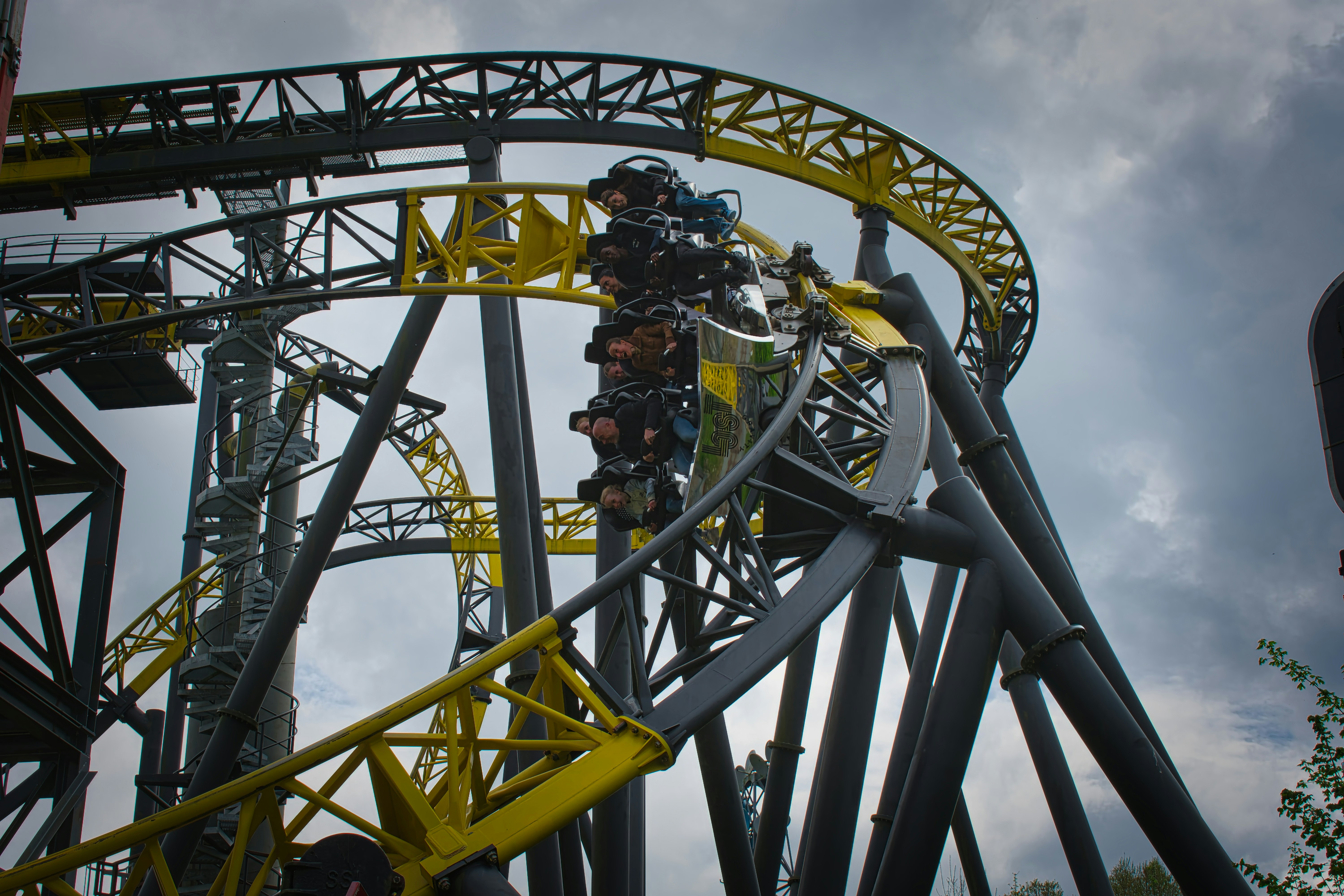 Thrill on the Tracks: Passengers Crest a Rollercoaster Loop