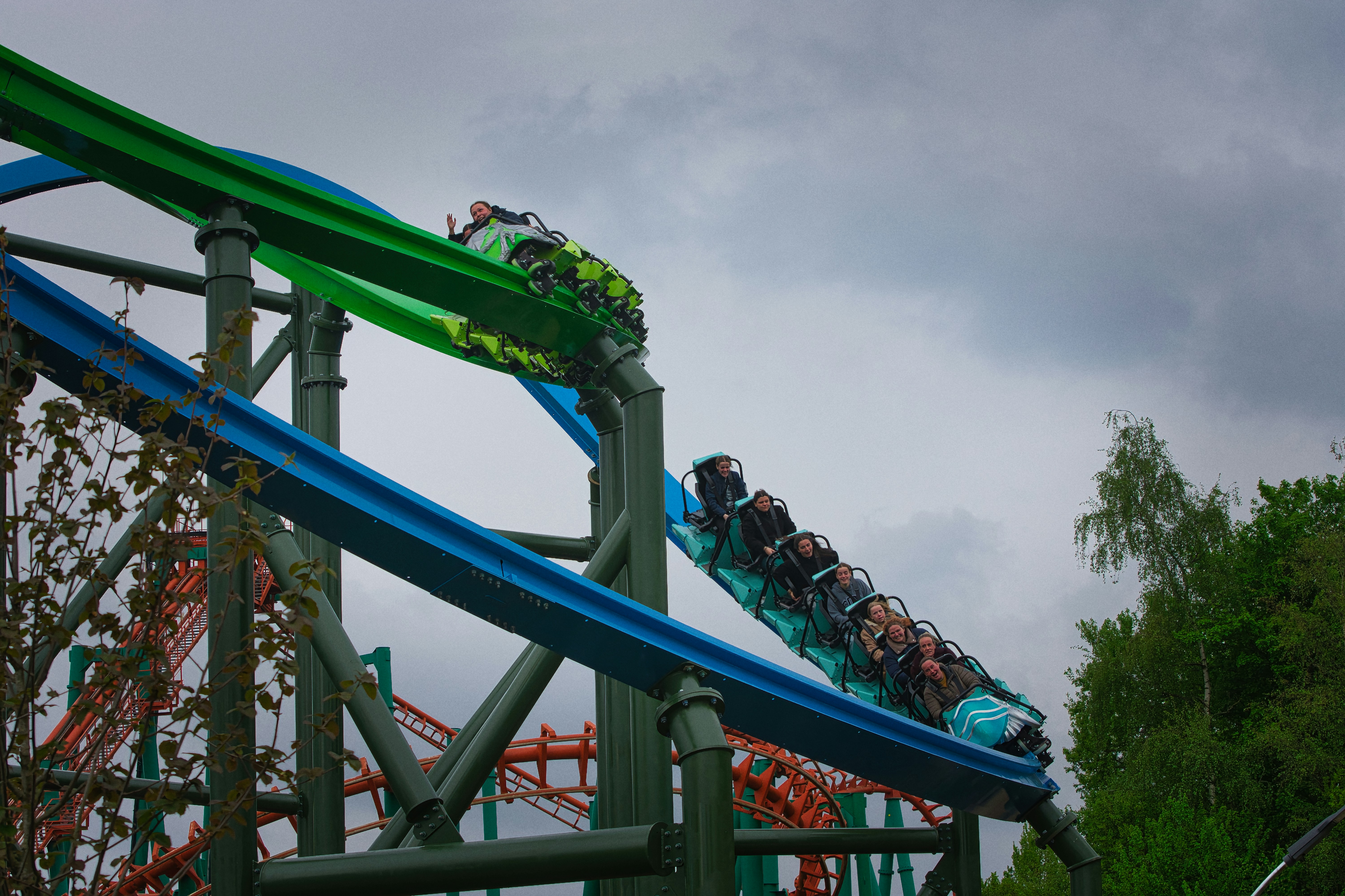 Whirl of Colorful Rails: Riders Rushing Along a Coaster