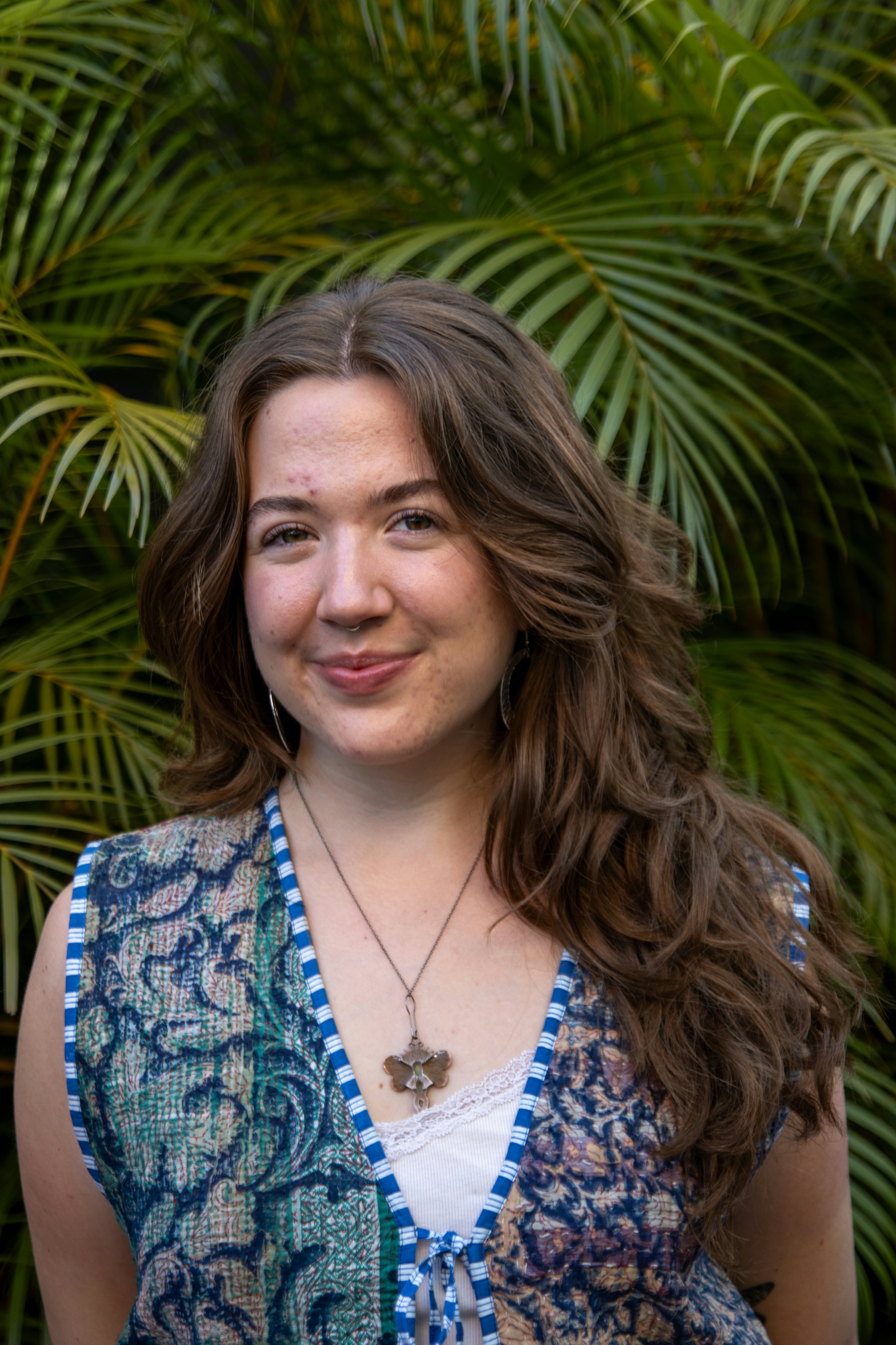 Portrait in a Tangle of Green: A Warm Smile Amid Tropical Foliage