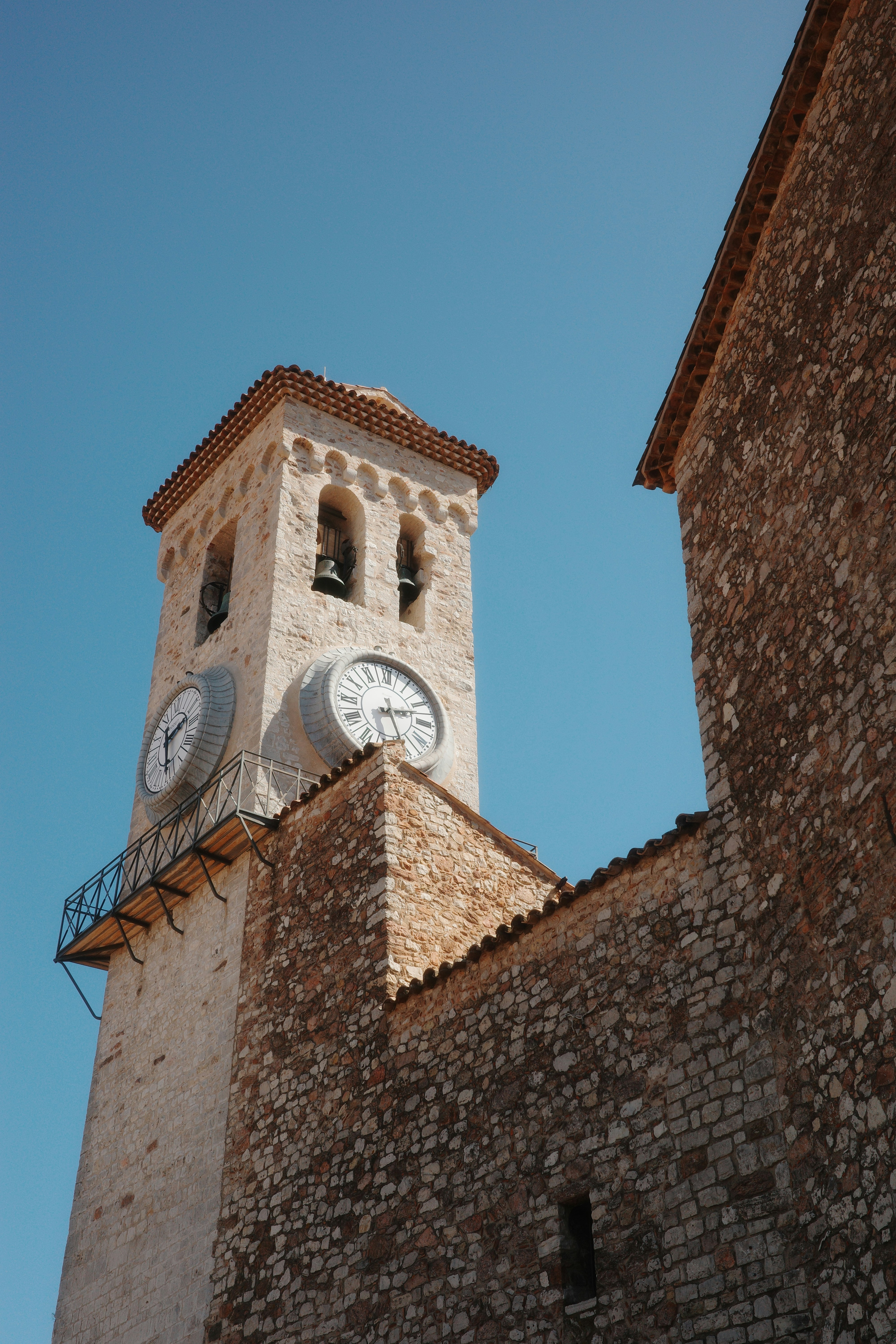 Stone Clock Tower Reaching Toward an Azure Sky
