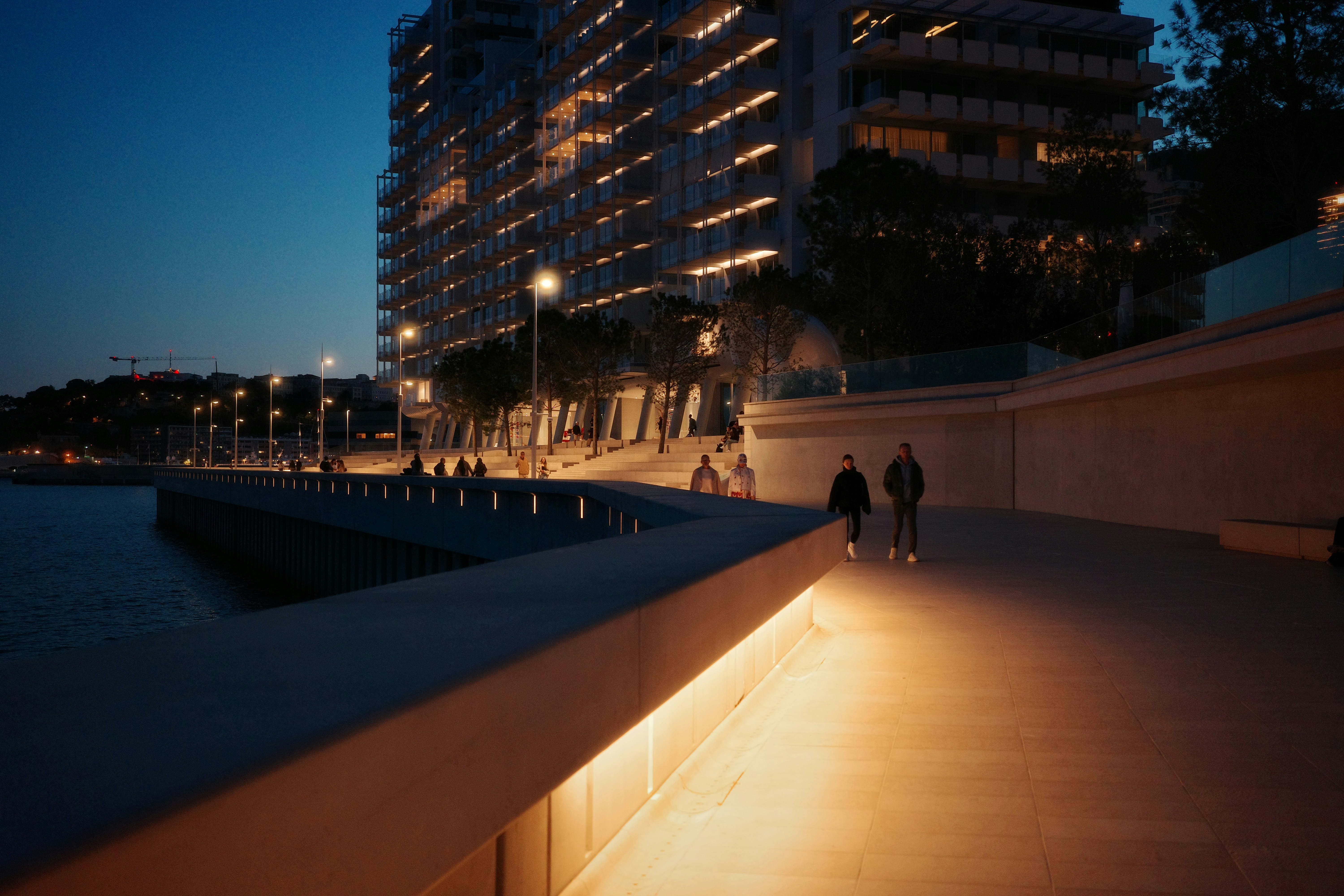 Evening Promenade by the Illuminated Waterfront