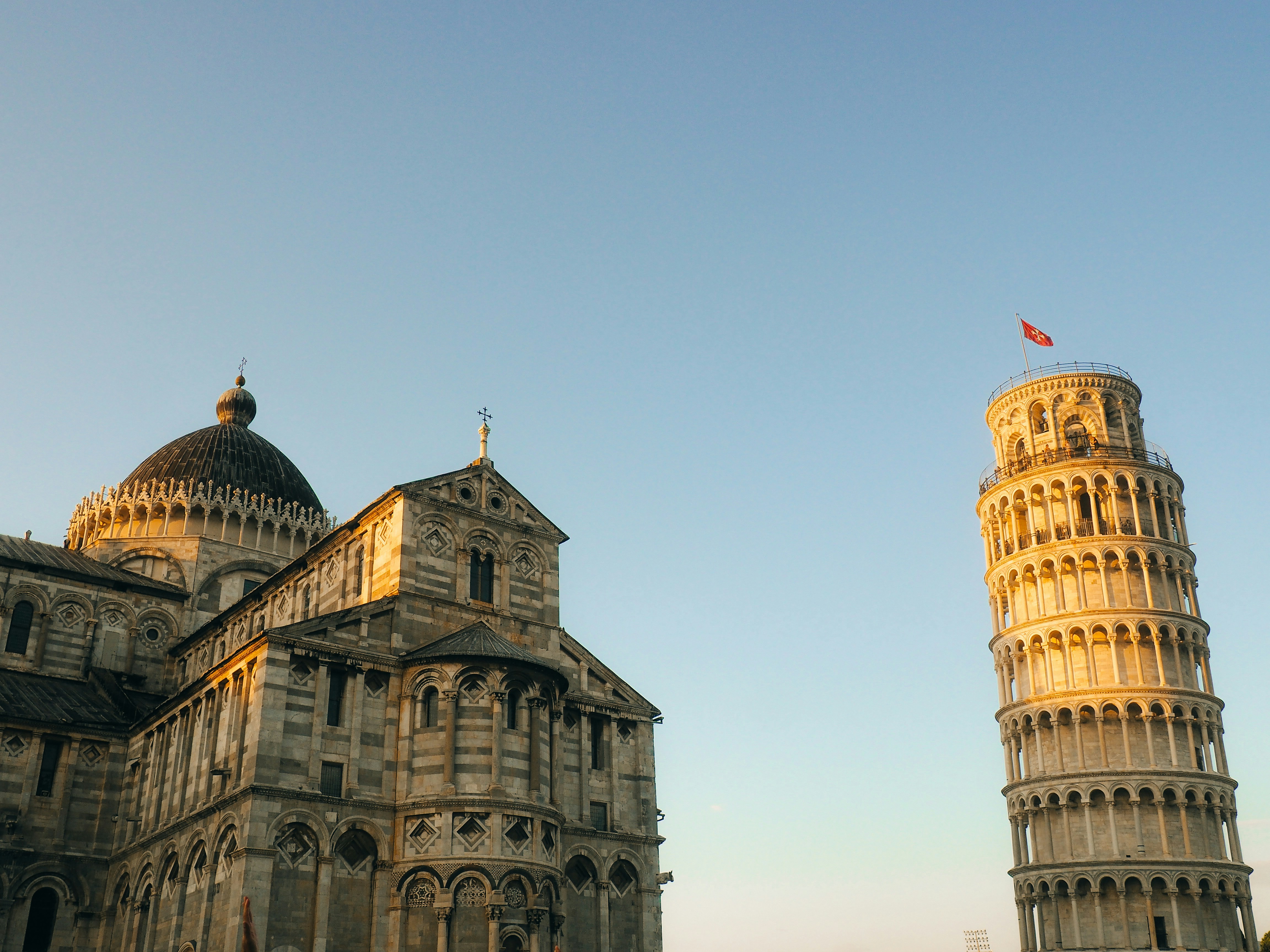 Stone Balance: The Leaning Bell and Cathedral Facades at Dusk