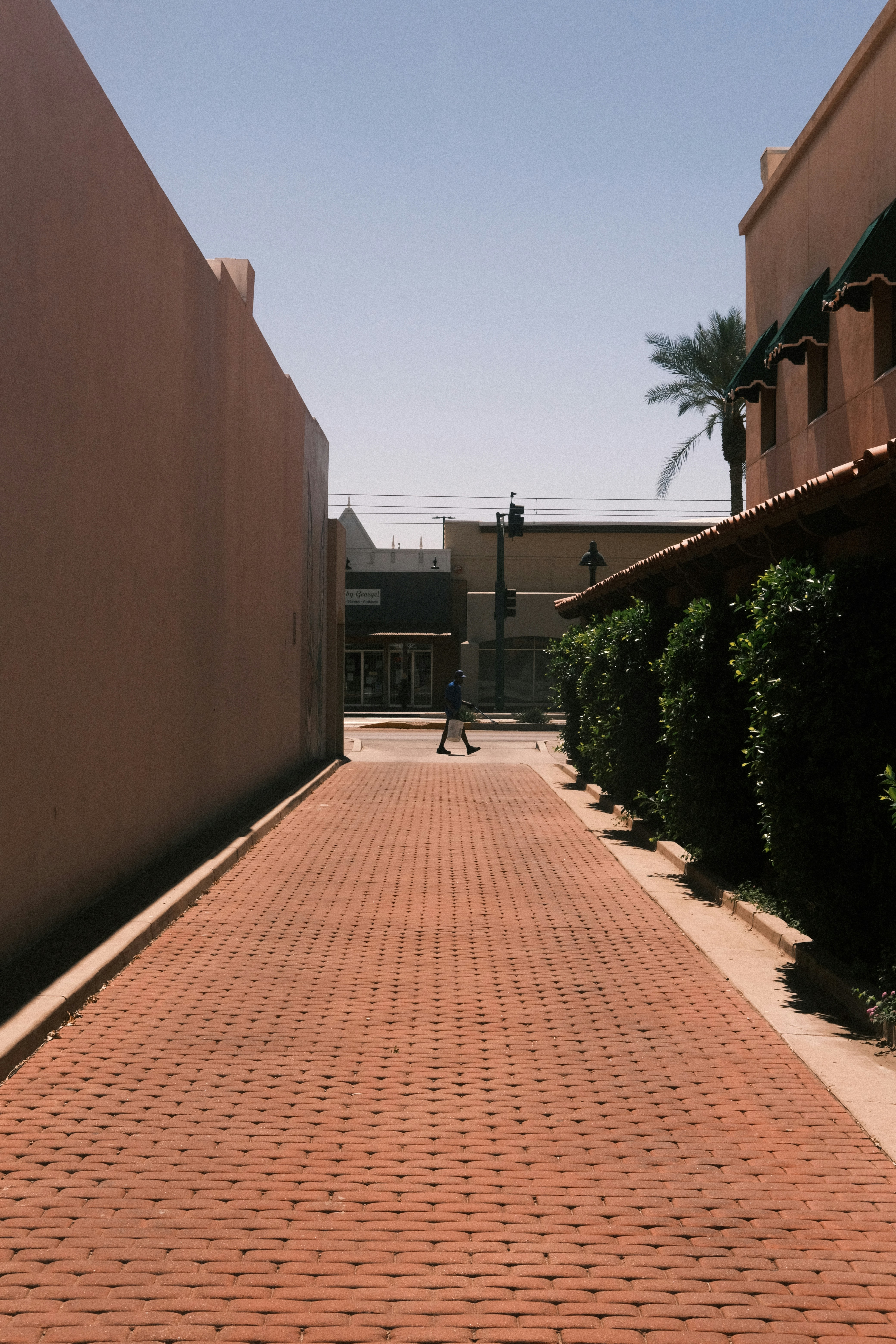 Sunlit Alleyway: A Quiet Walk Between Walls
