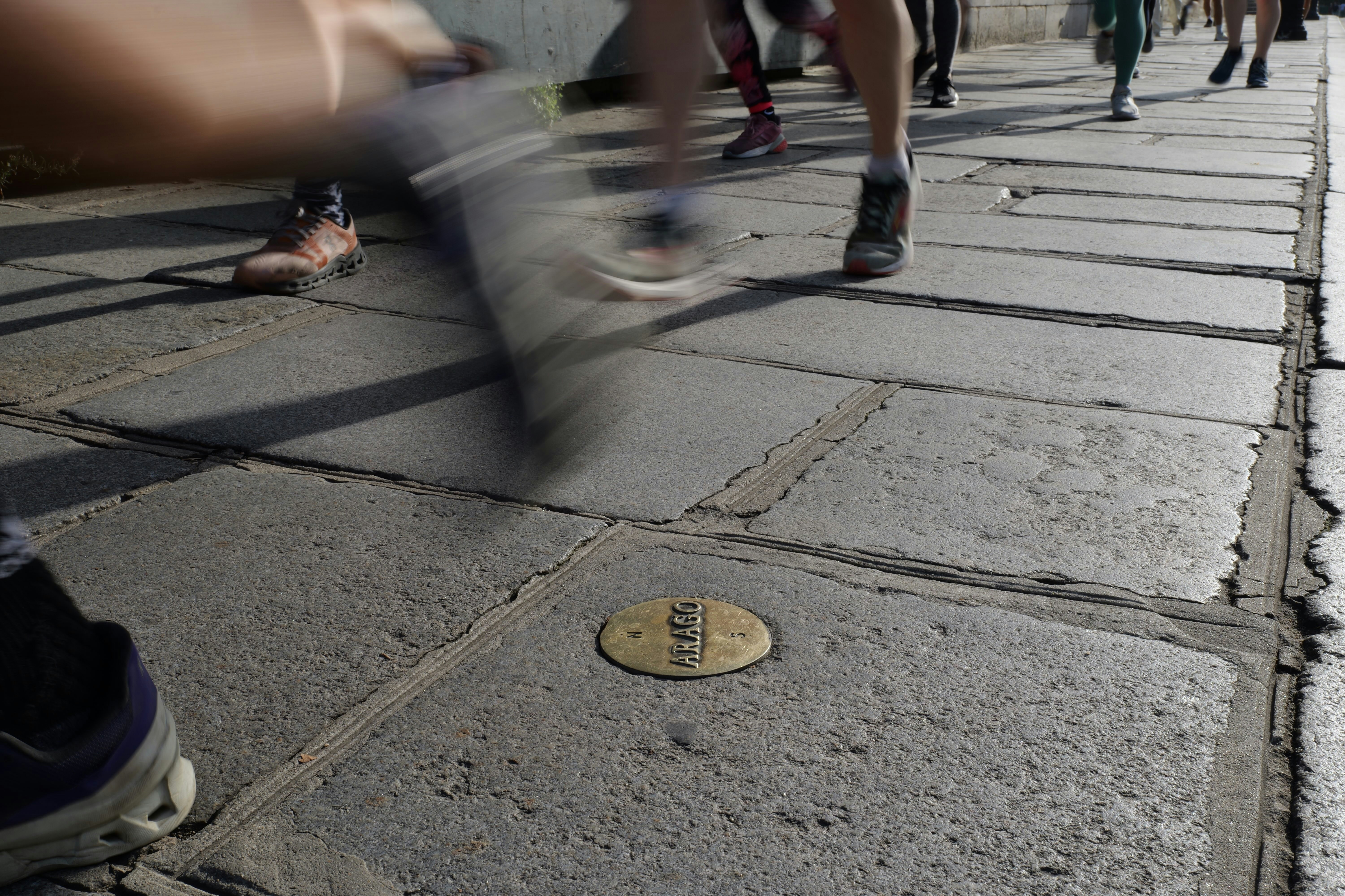 Rush on the Pavers: Feet in Motion Across a City Walk