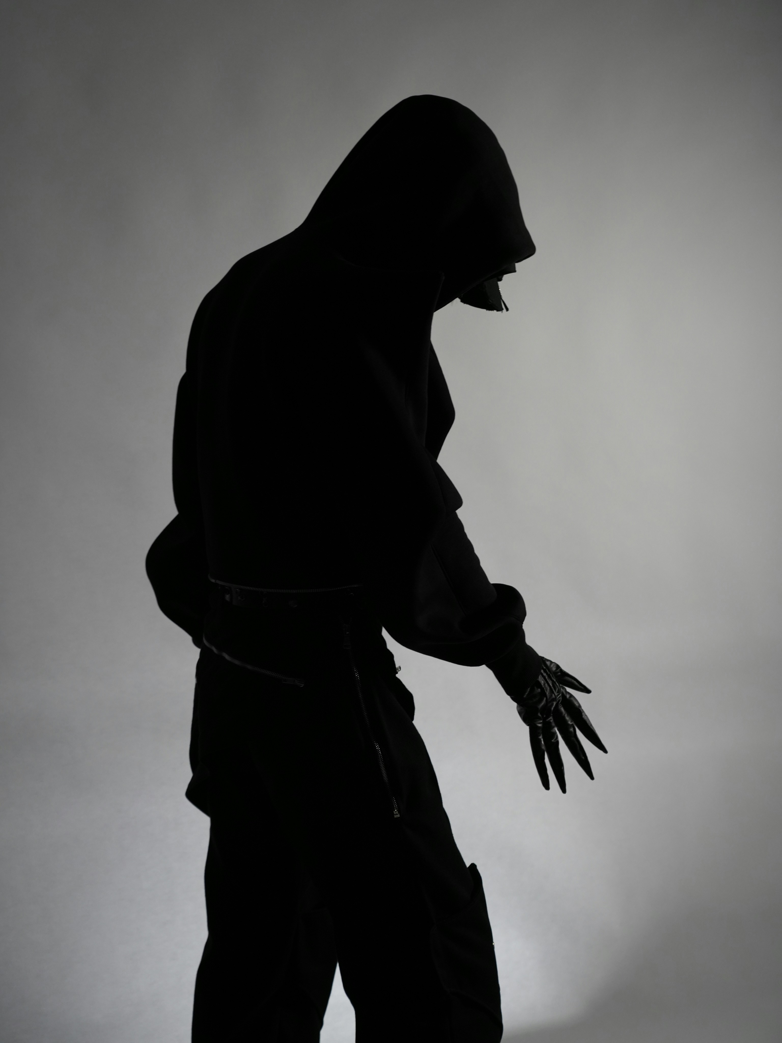 Shadowed Figure in Motion: A Quiet Silhouette Against Soft Light