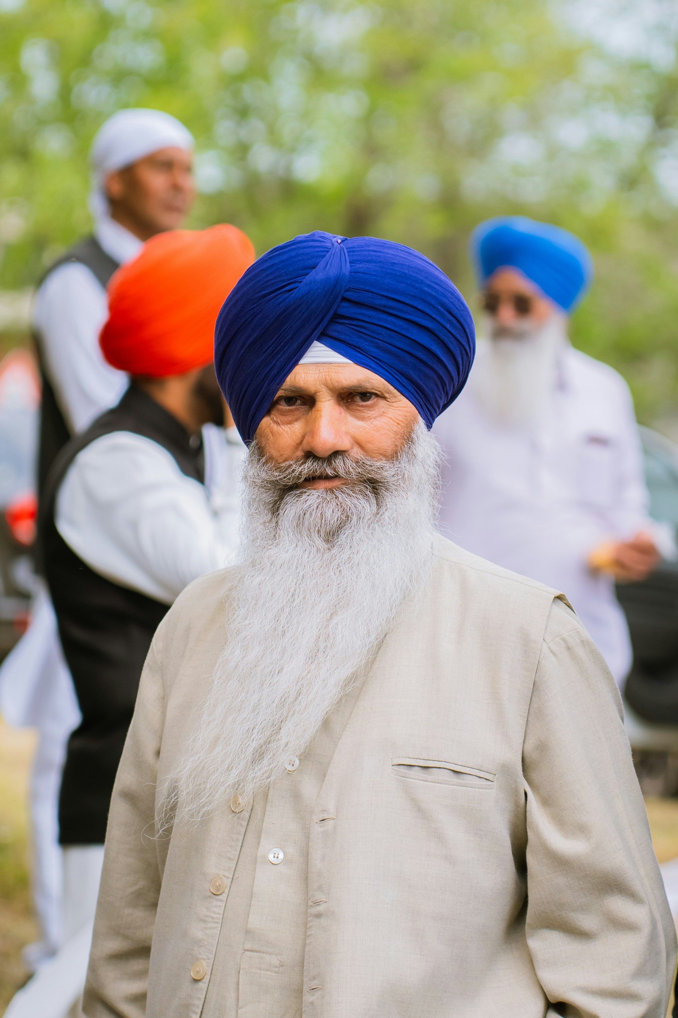 Blue Turban, Focused Gaze: A Moment Among Friends