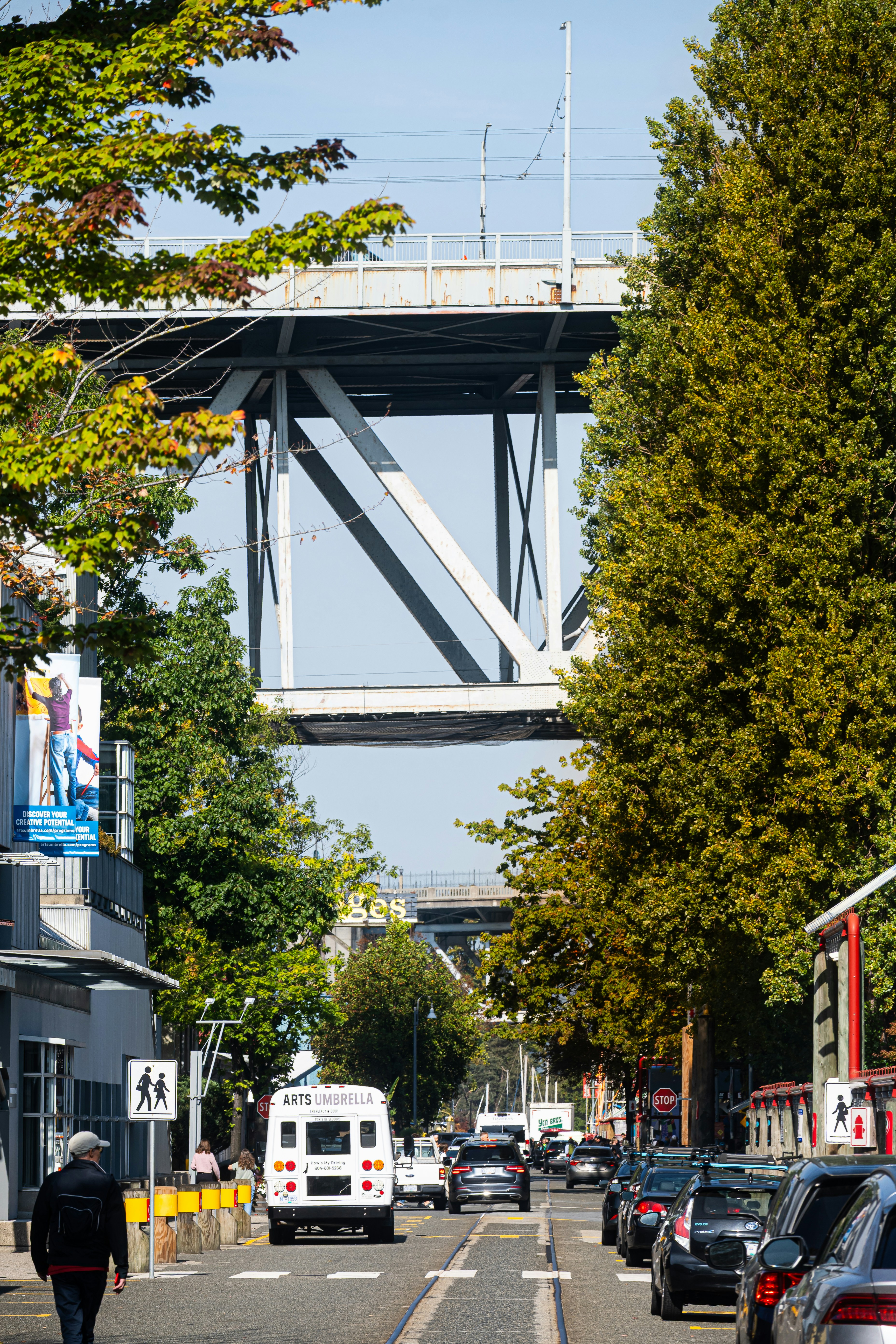 Urban Bridge Frame: A Street Quietly Under a Rising Span